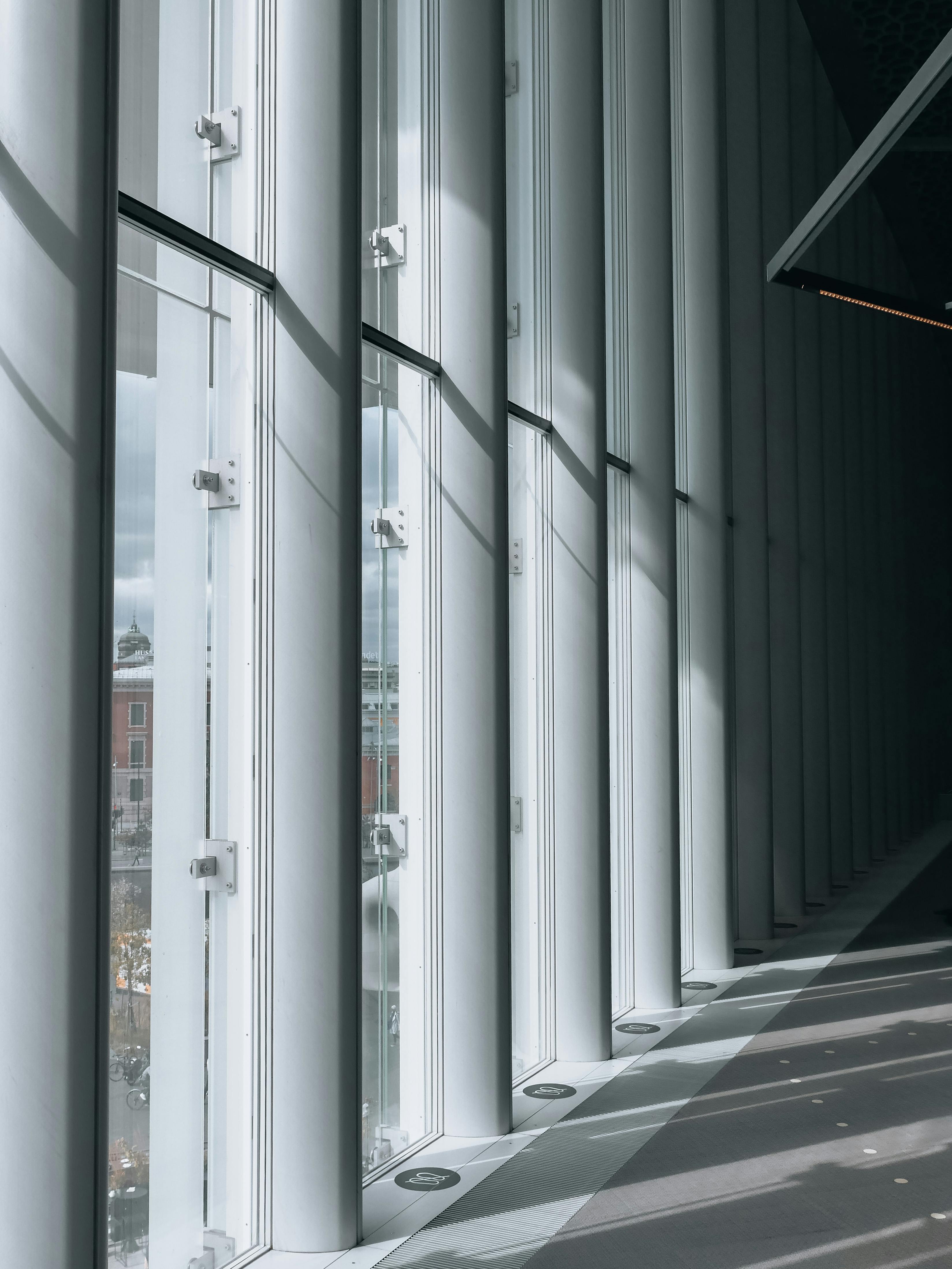 Row of Columns Supporting Glass Walls of a Modern Building · Free Stock ...