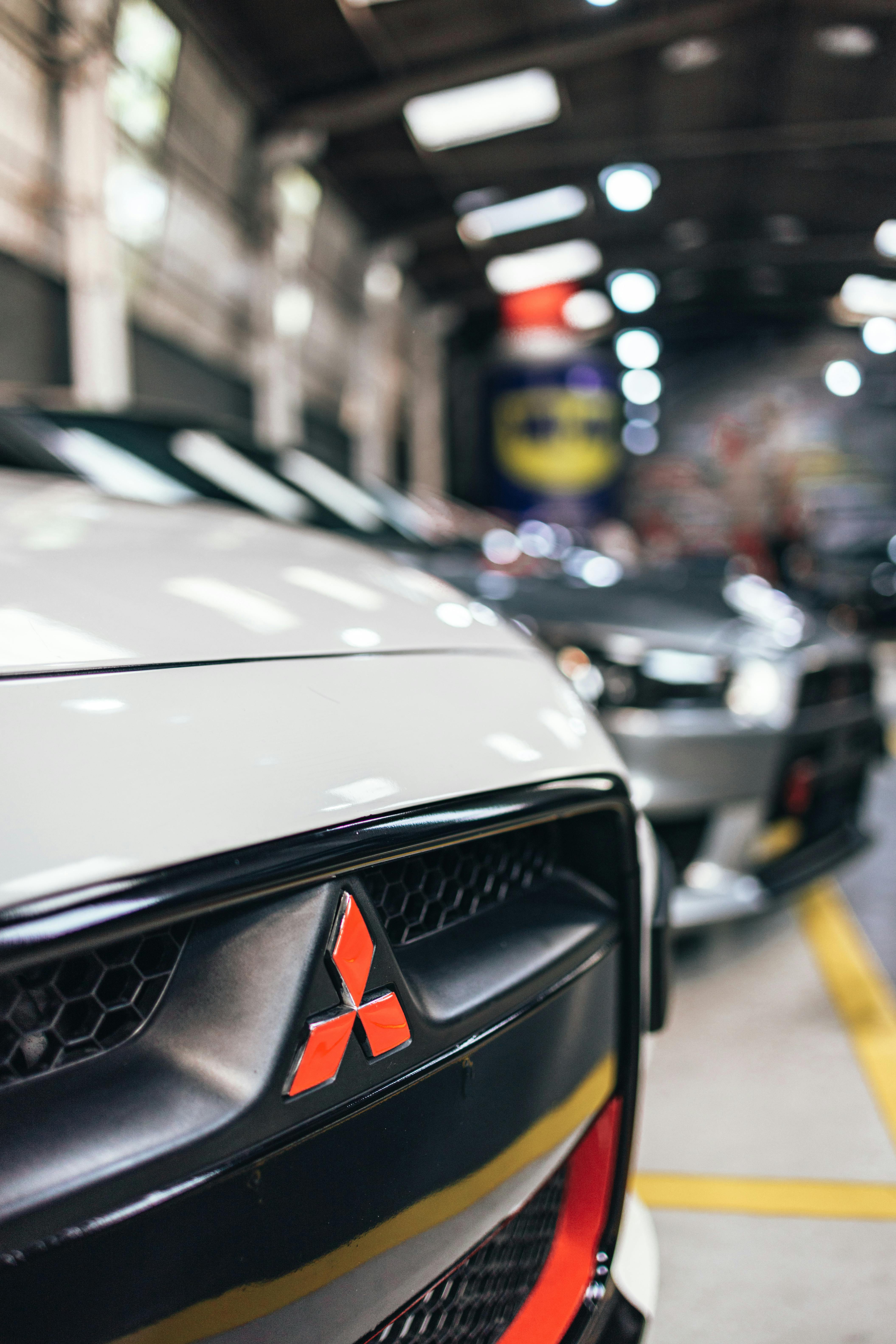 Mitsubishi Emblem on a White Car · Free Stock Photo
