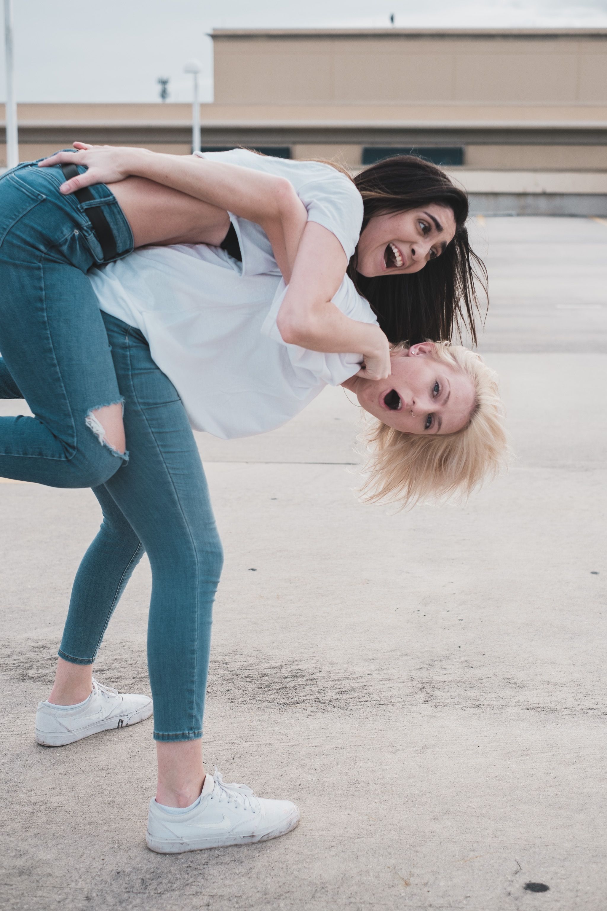 Woman in White Shirt Carrying Woman on her Back · Free Stock Photo