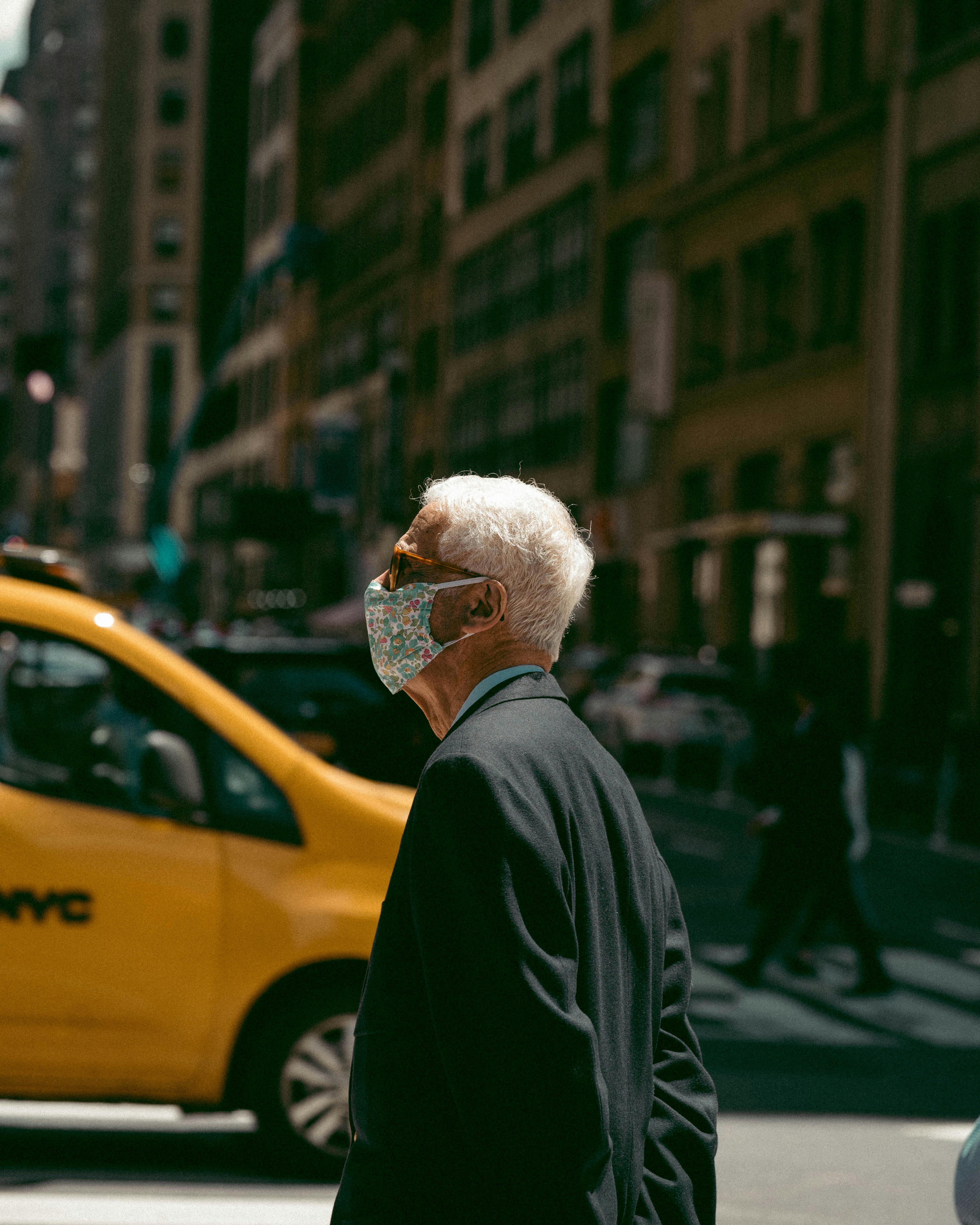 Man in White Polo Shirt Holding Balloons · Free Stock Photo