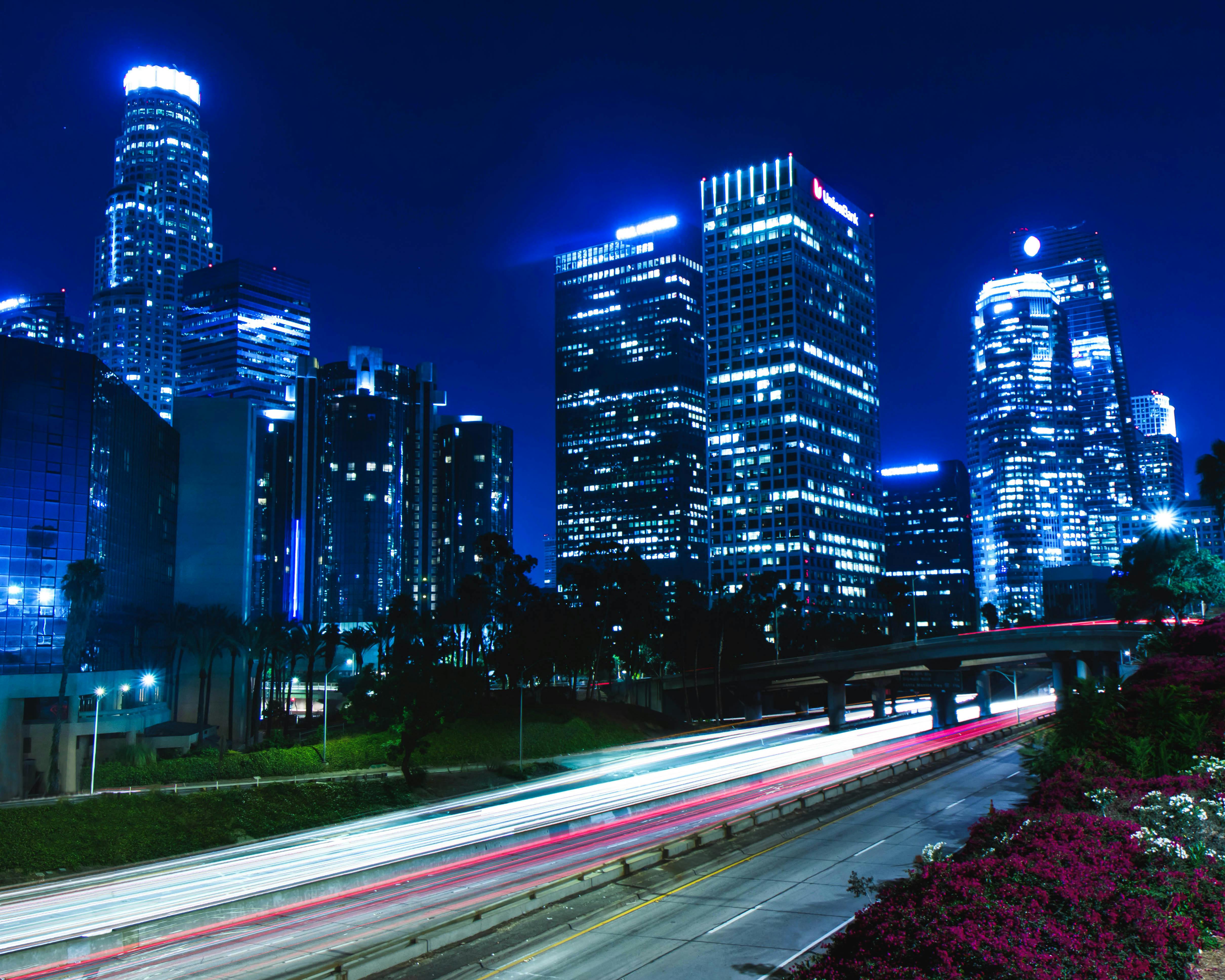 Time-Lapse Photo of High-Rise Buildings at Night · Free Stock Photo