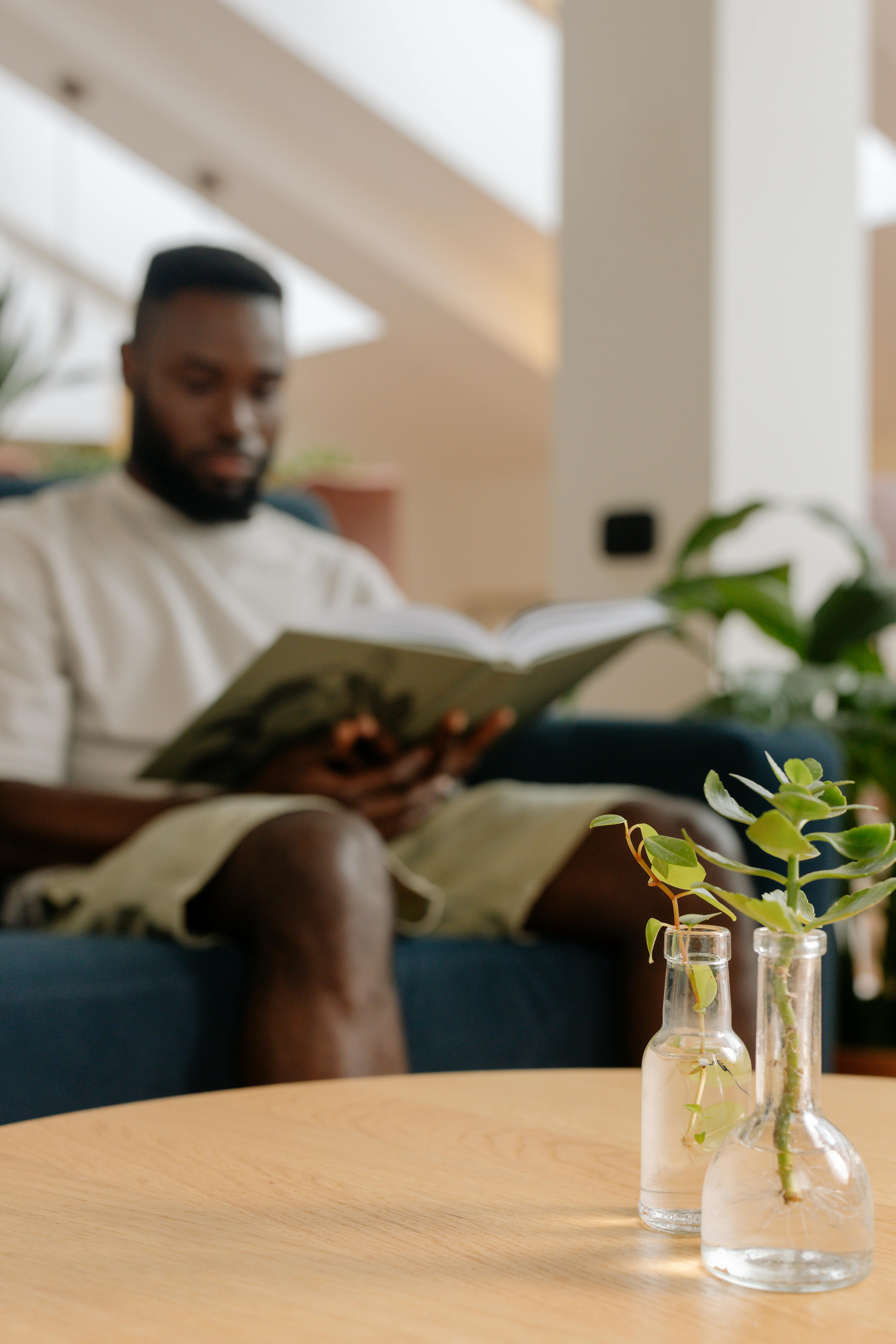 A Man Sitting on the Sofa in the Living Room · Free Stock Photo
