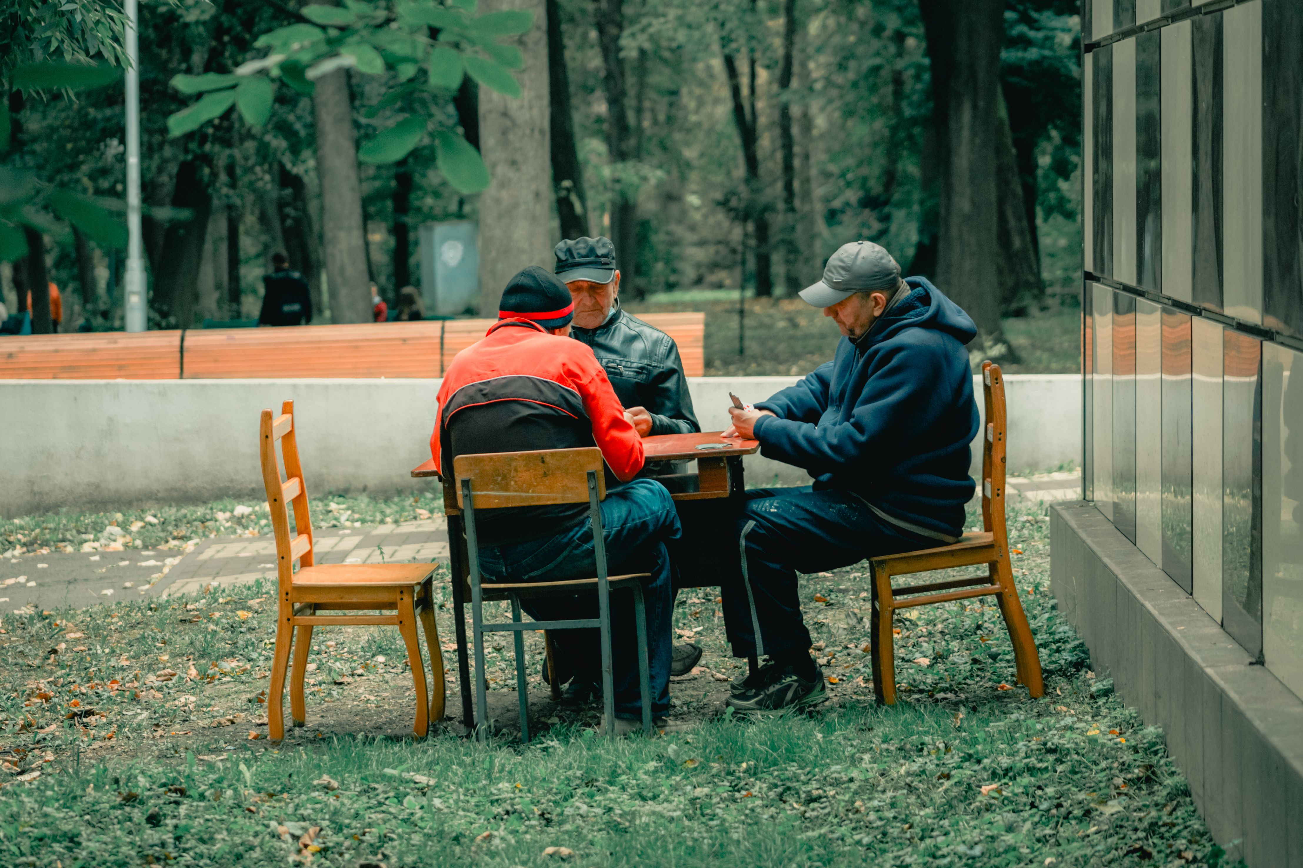 People Sitting at Table Playing Cards · Free Stock Photo