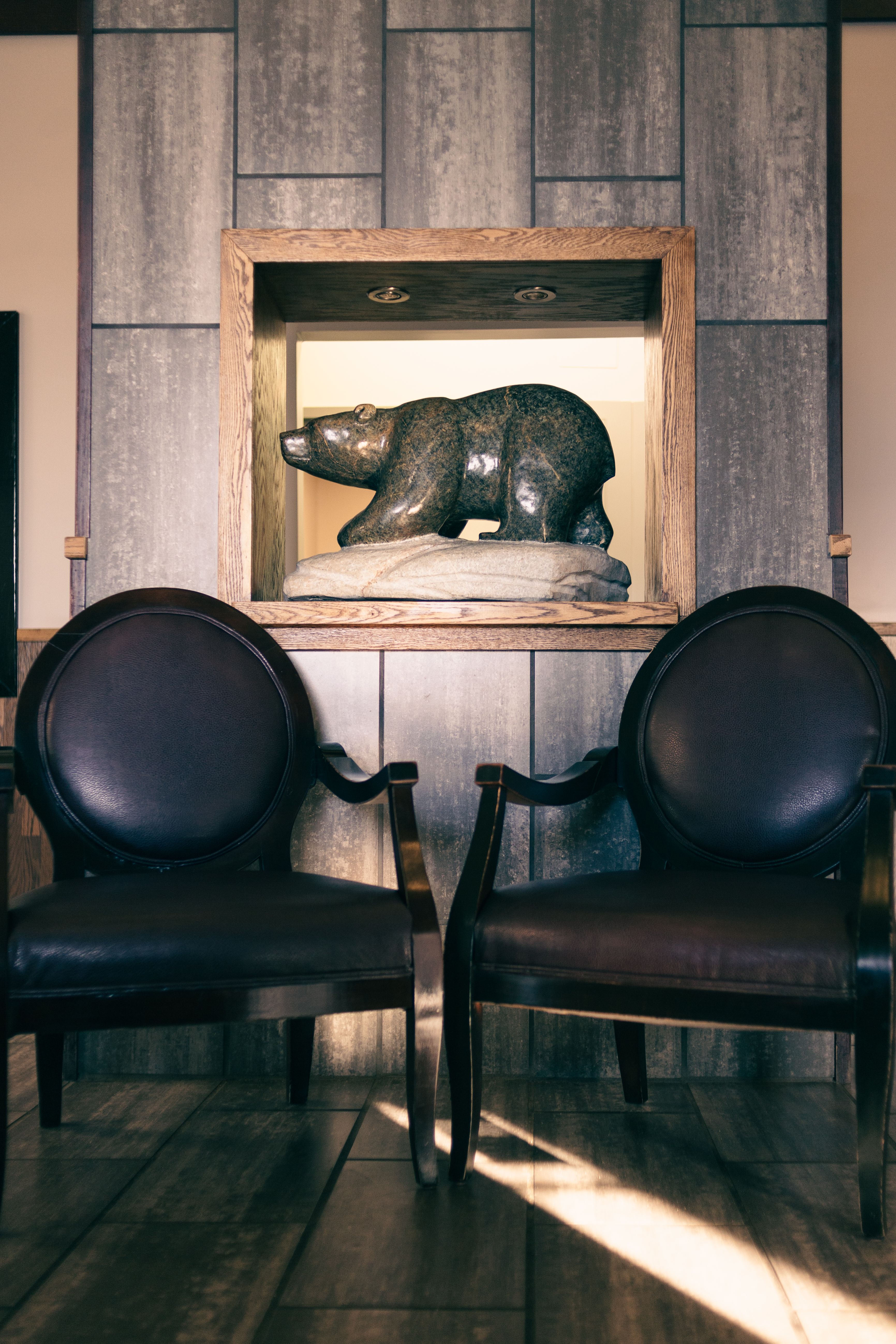 Two Leather Chairs and a Sculpted Bear · Free Stock Photo