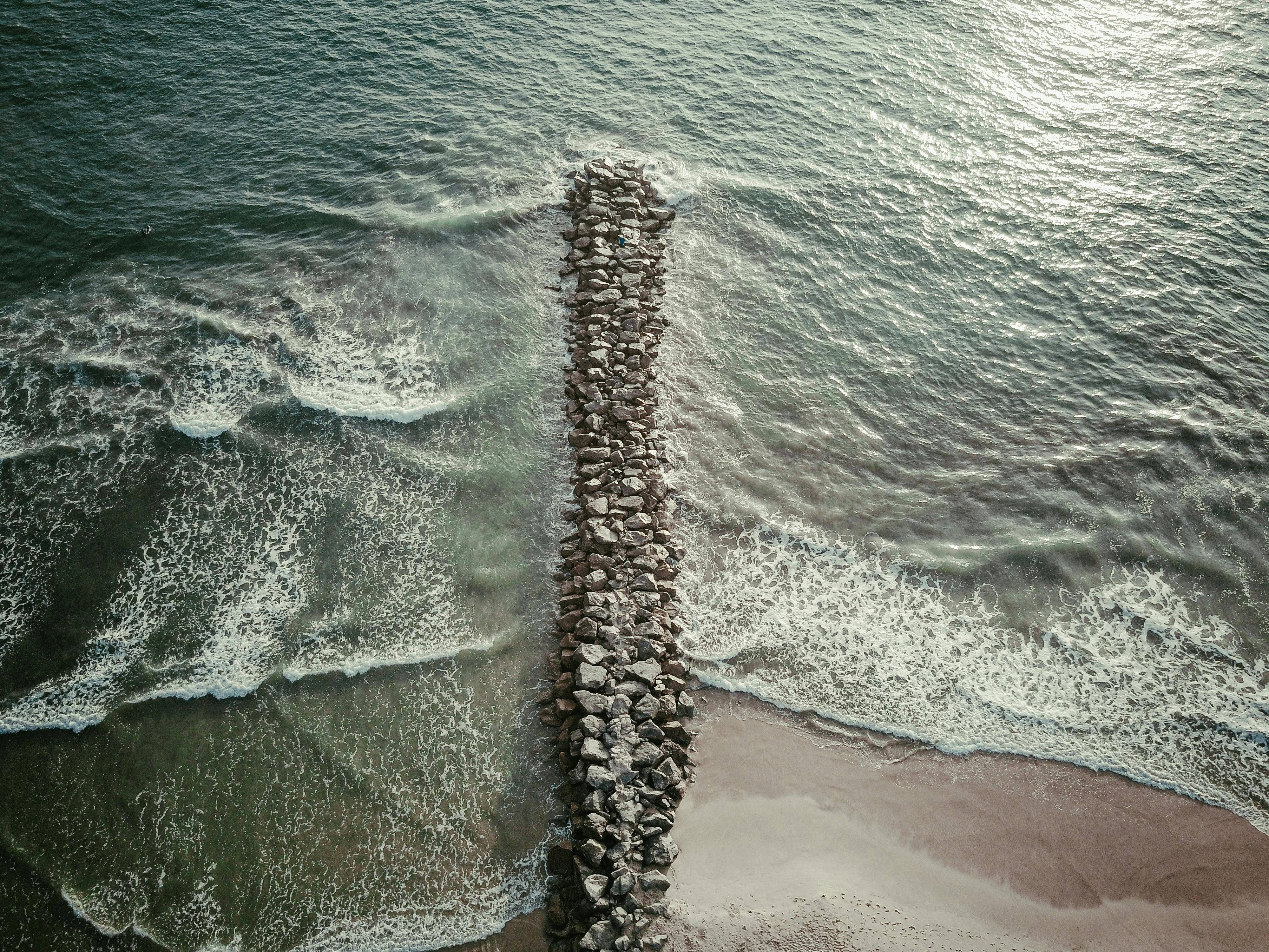 Aerial View of Breakwater Rocks in the Seashore · Free Stock Photo