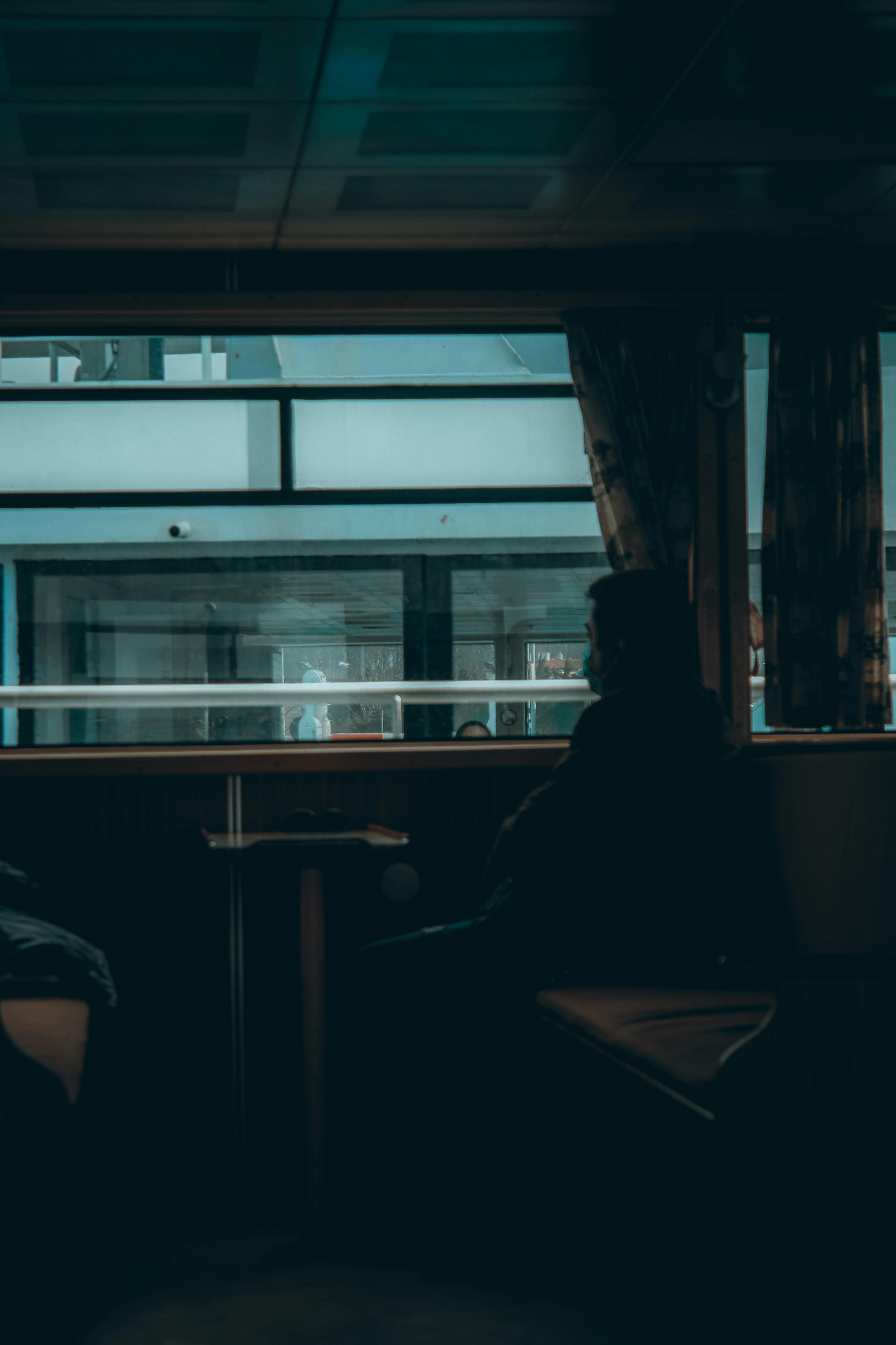 Person Sitting near Window · Free Stock Photo