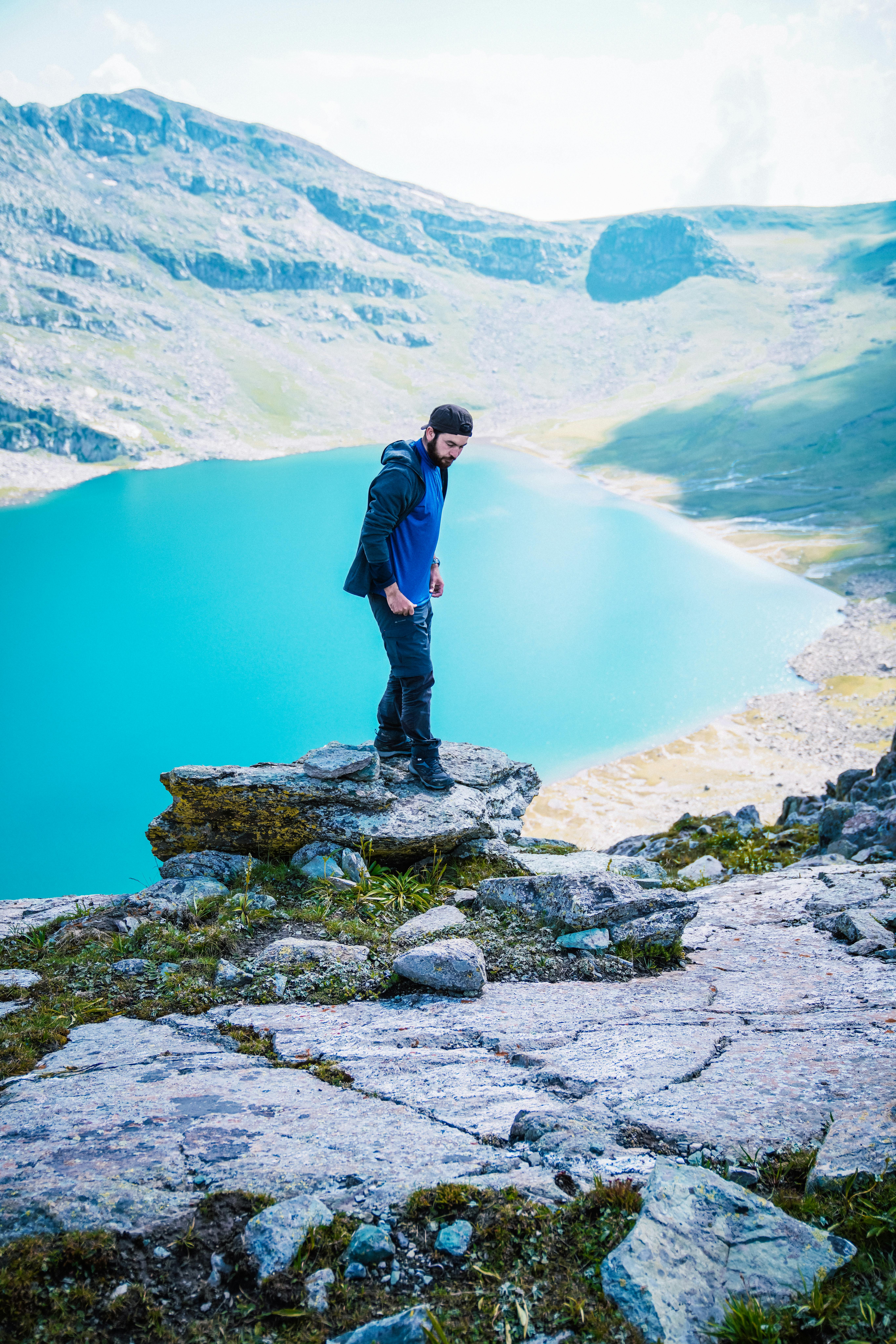 Man on Rocks over Lake · Free Stock Photo