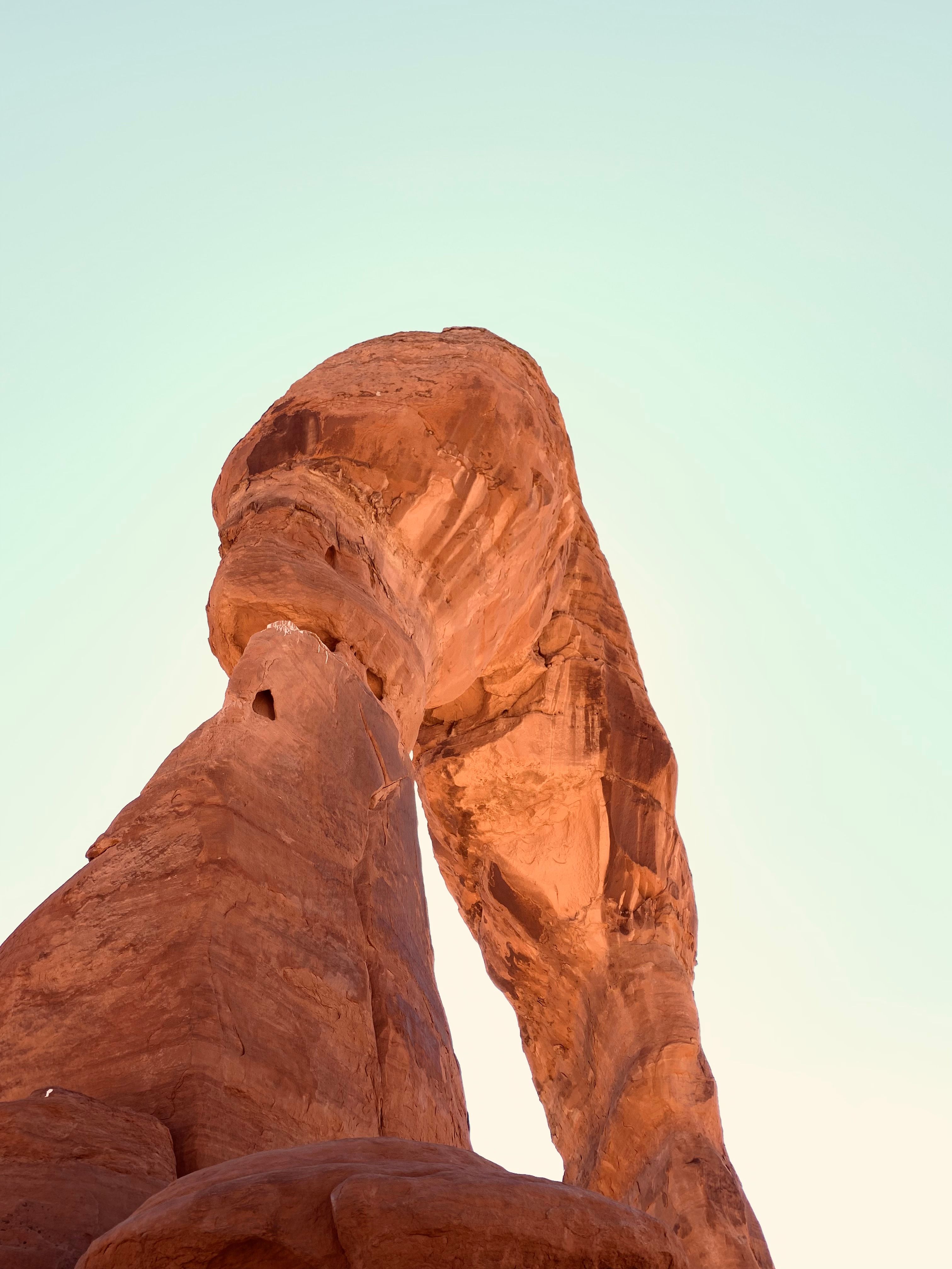 Arched Brown Rock Formation Under Clear Sky · Free Stock Photo