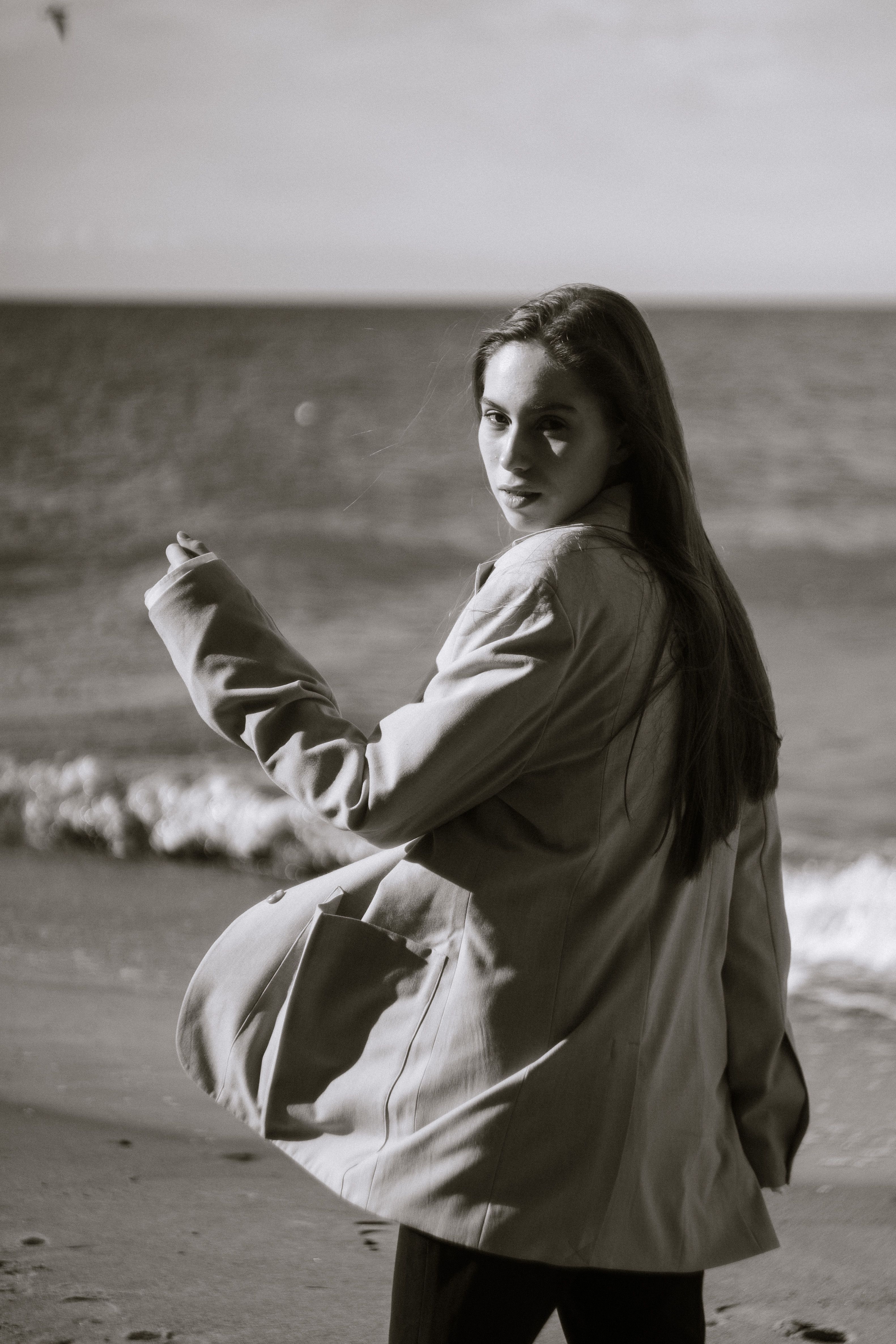 Monochrome Photo of a Woman Looking Back at the Camera · Free Stock Photo