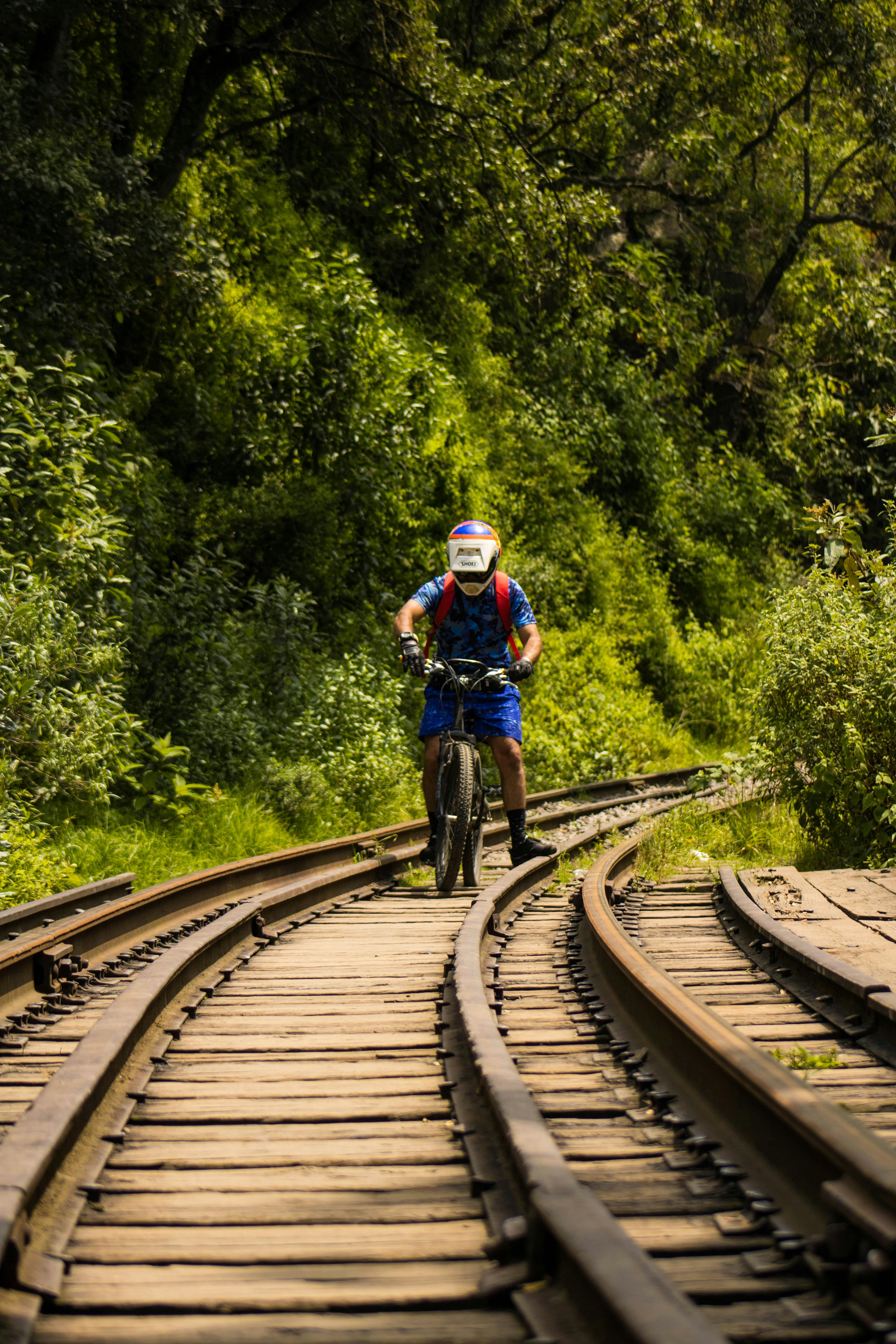 Biker Riding Along Railway Tracks · Free Stock Photo