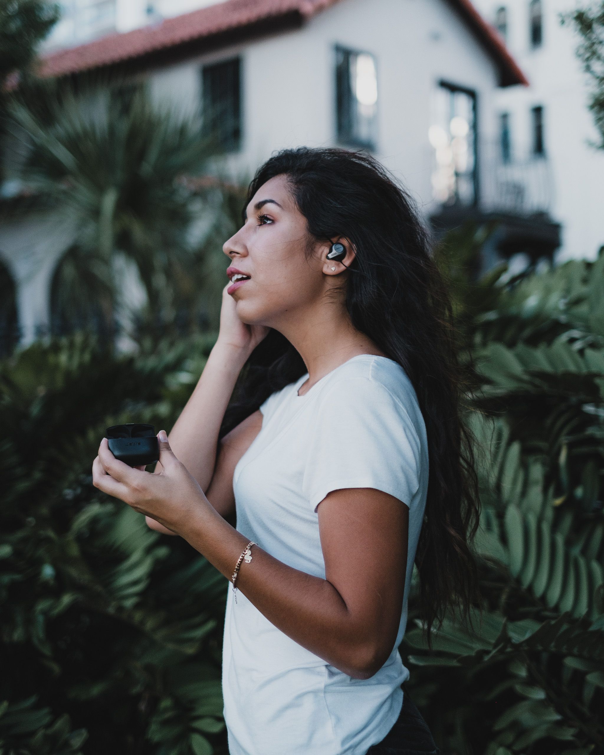 Portrait of a Young Woman with Wireless Earphones Smiling · Free Stock ...