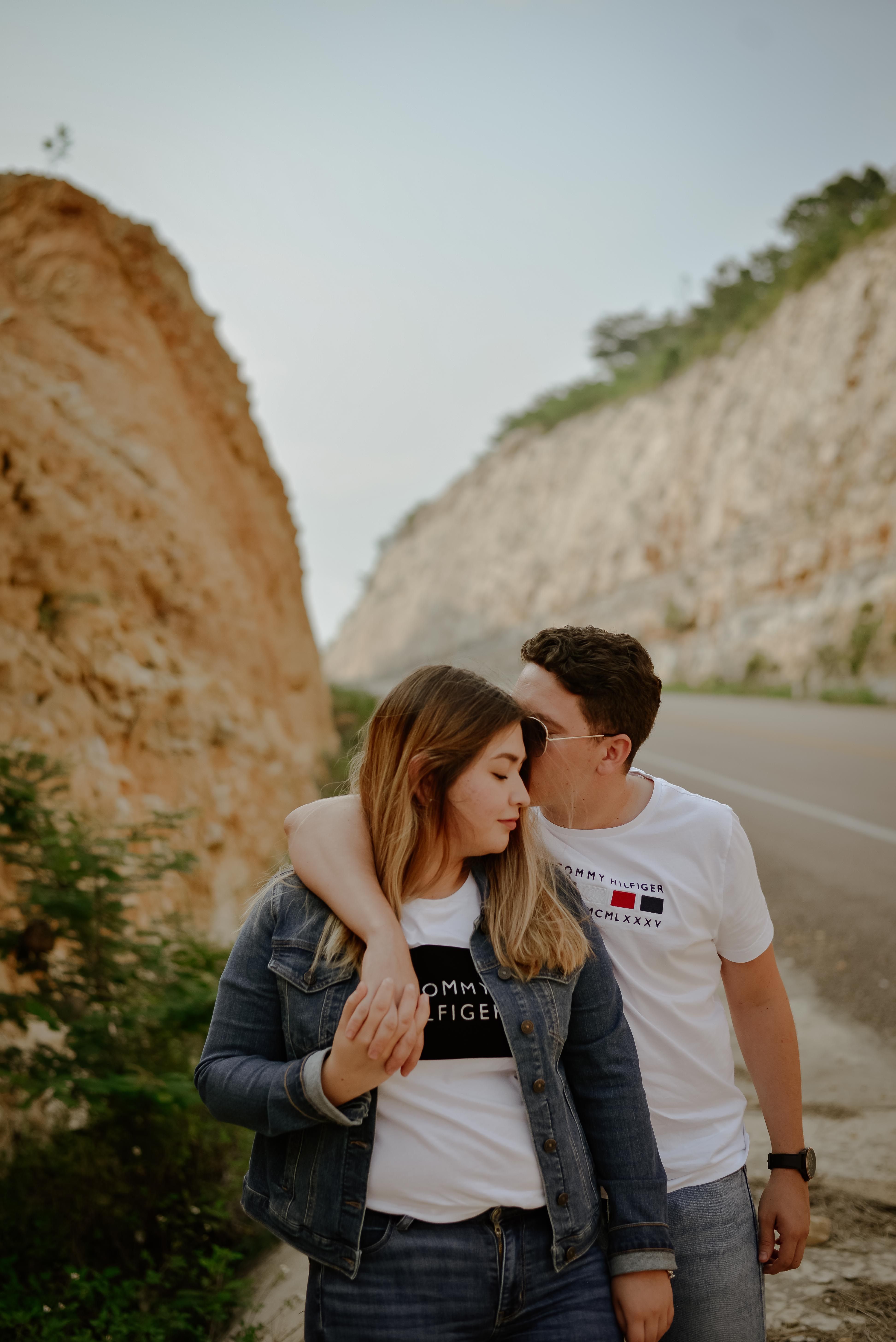 Man Standing Resting his Hand on a Woman's Shoulder · Free Stock Photo
