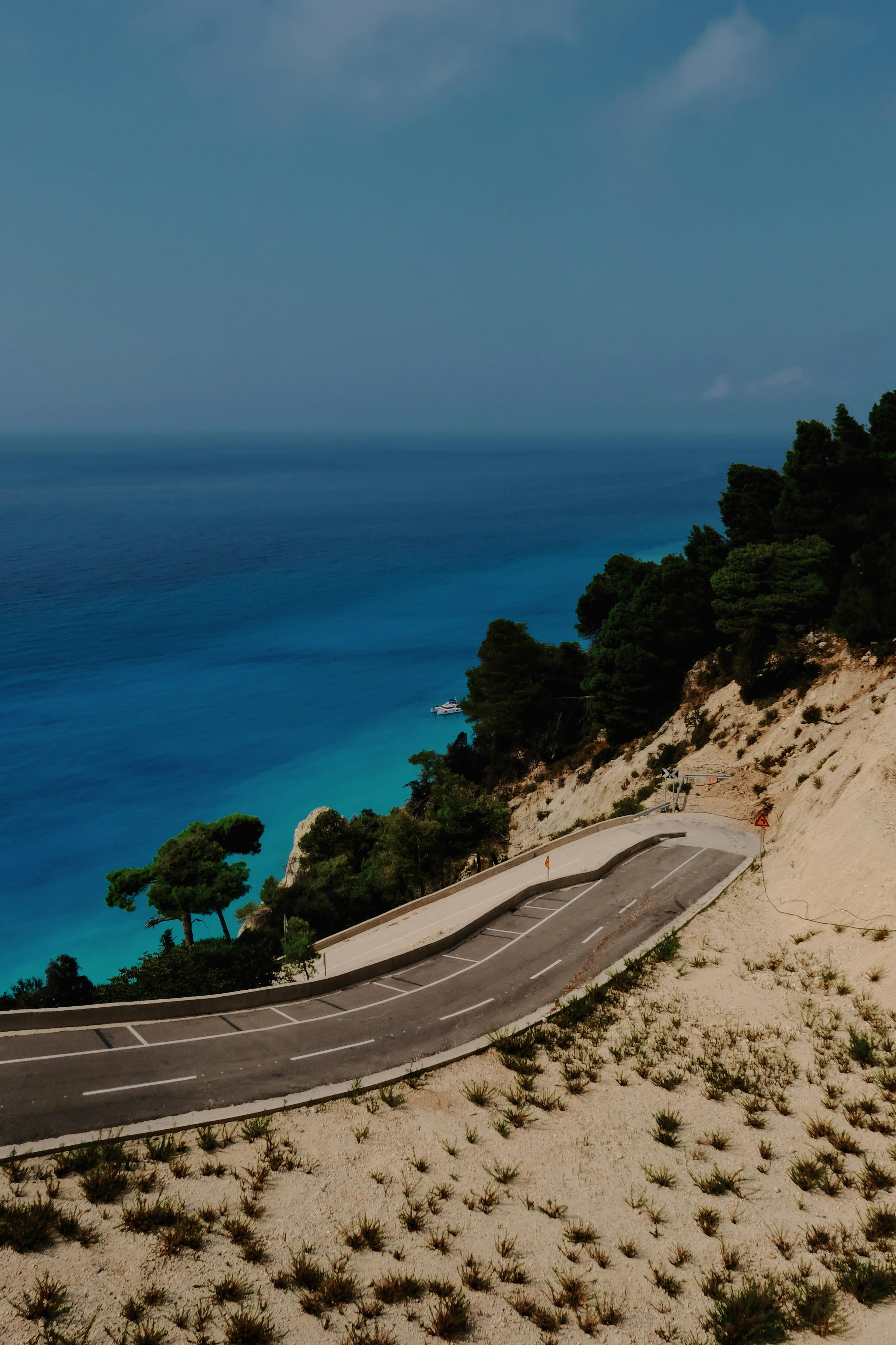 Gray Concrete Road Near the Ocean · Free Stock Photo