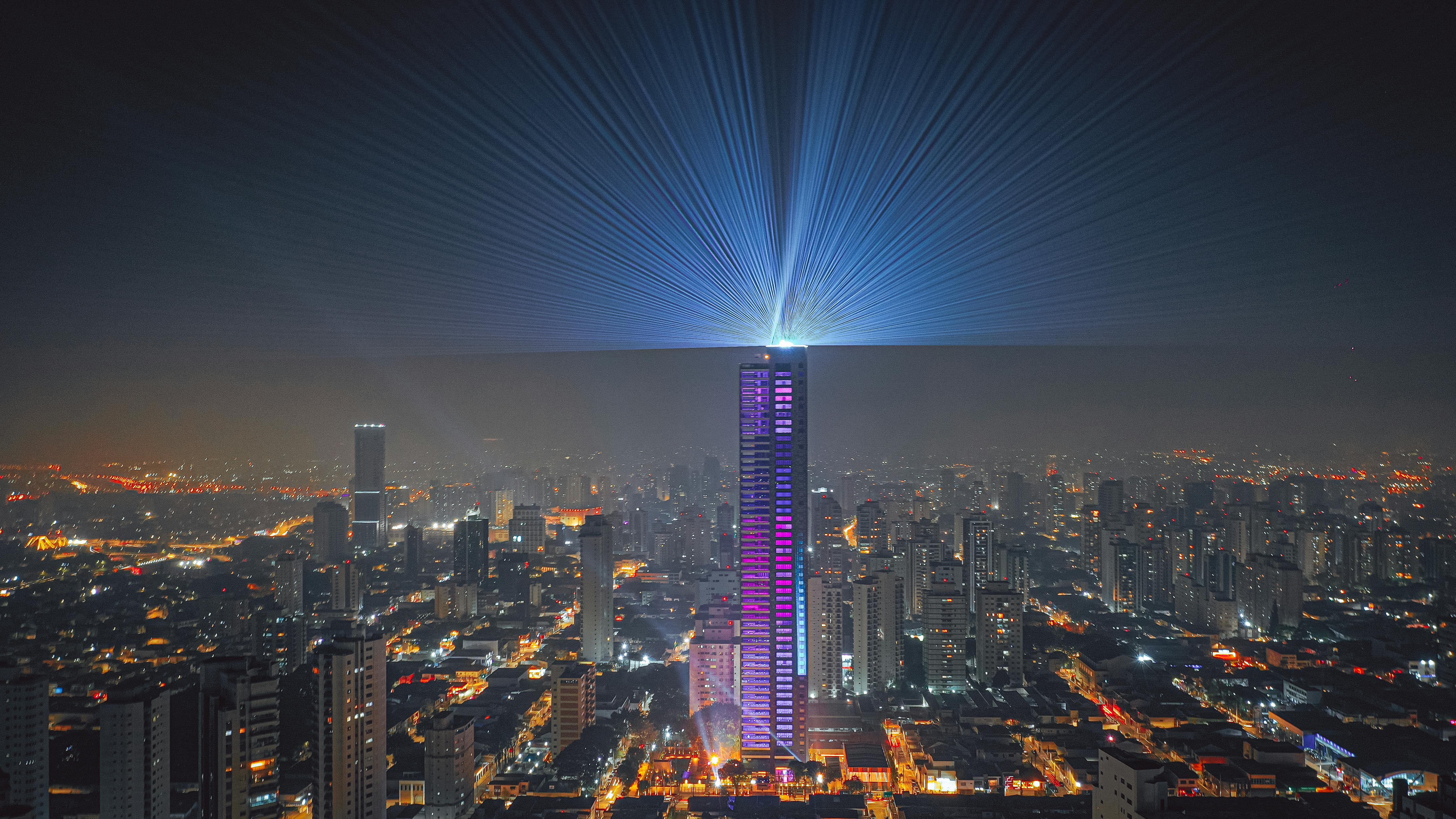 Illuminated Skyscrapers against Dark Night Sky · Free Stock Photo