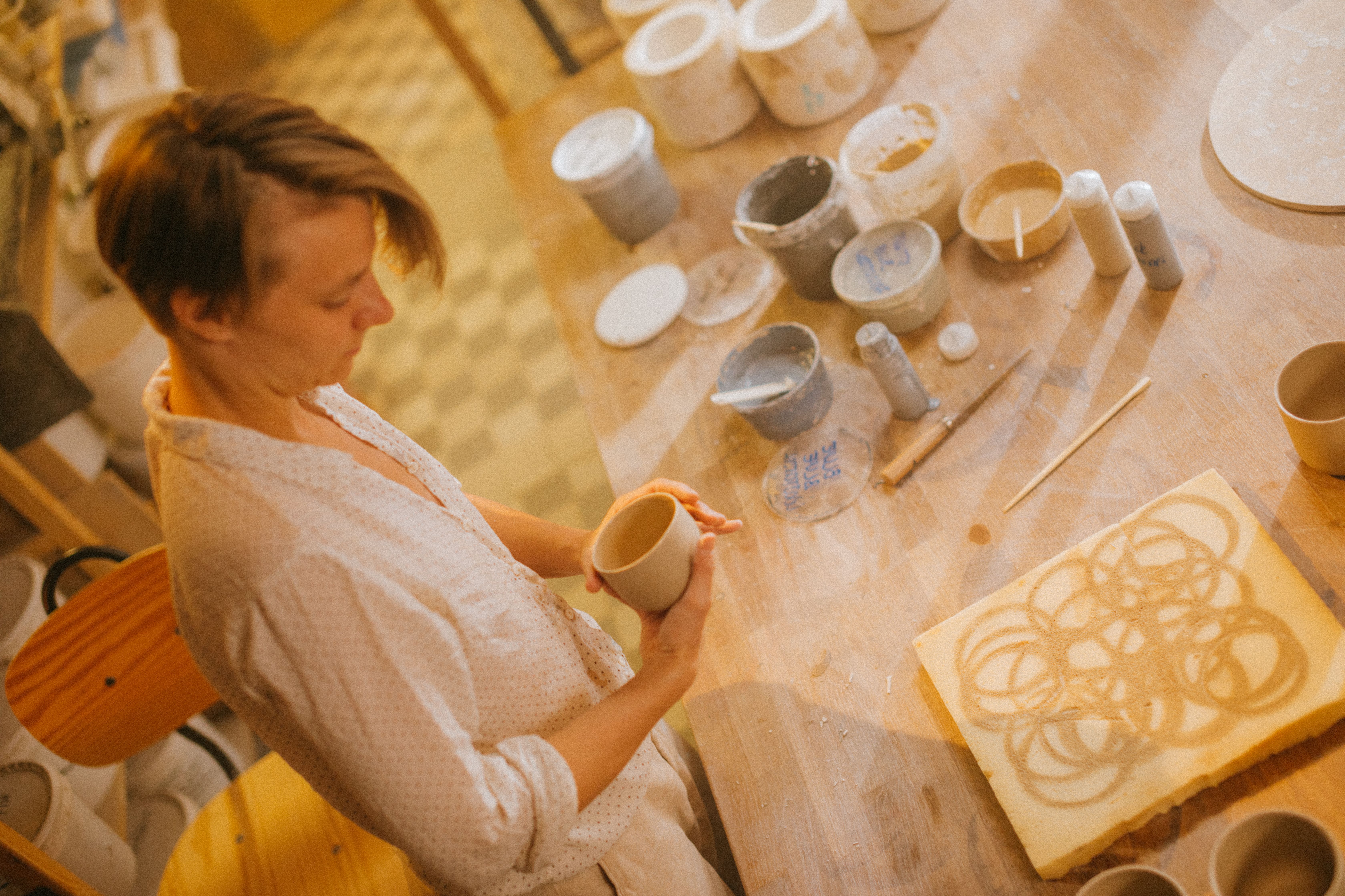An Artist Holding a Cup · Free Stock Photo