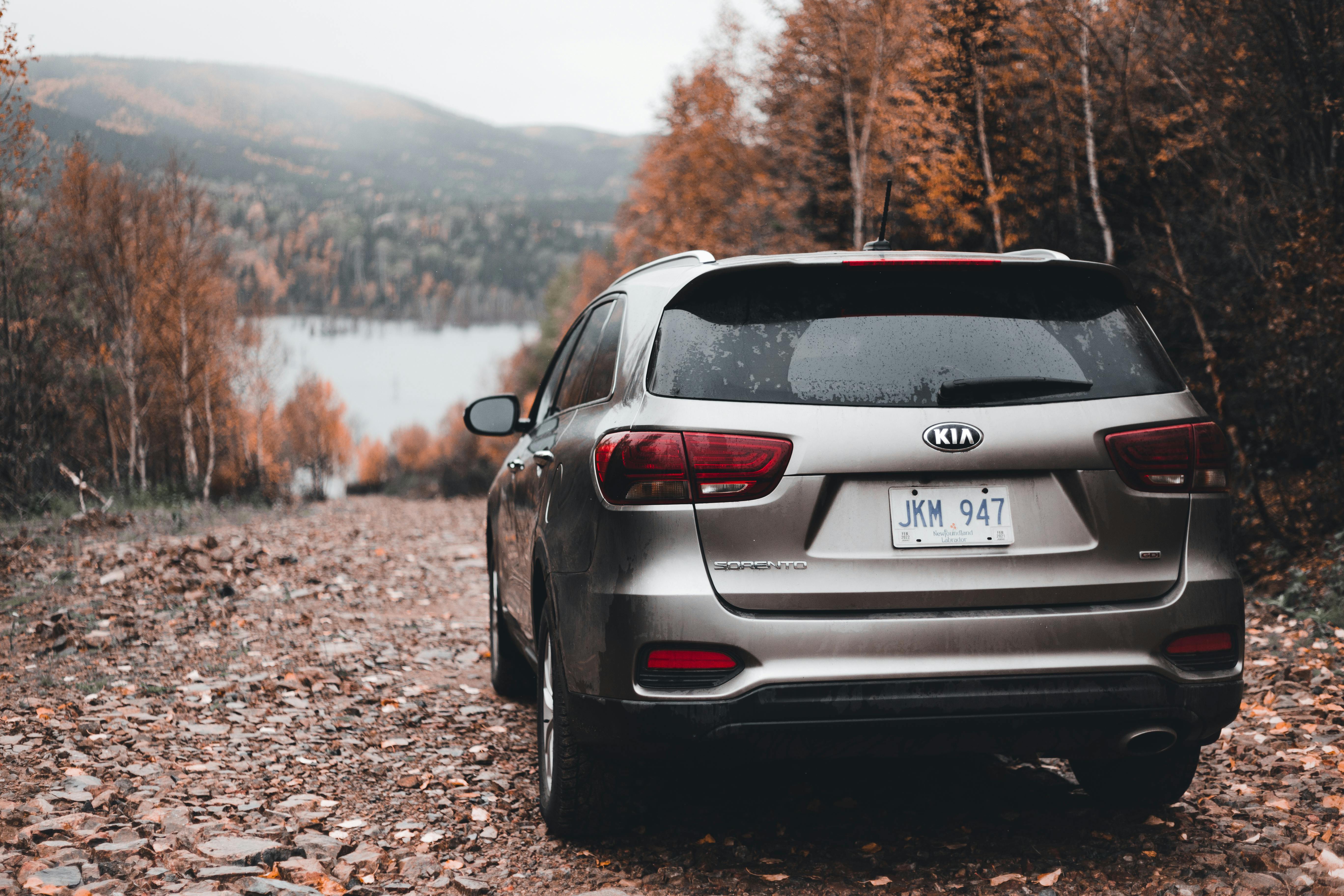 Back View of an SUV Car Parked on a Dirt Road · Free Stock Photo