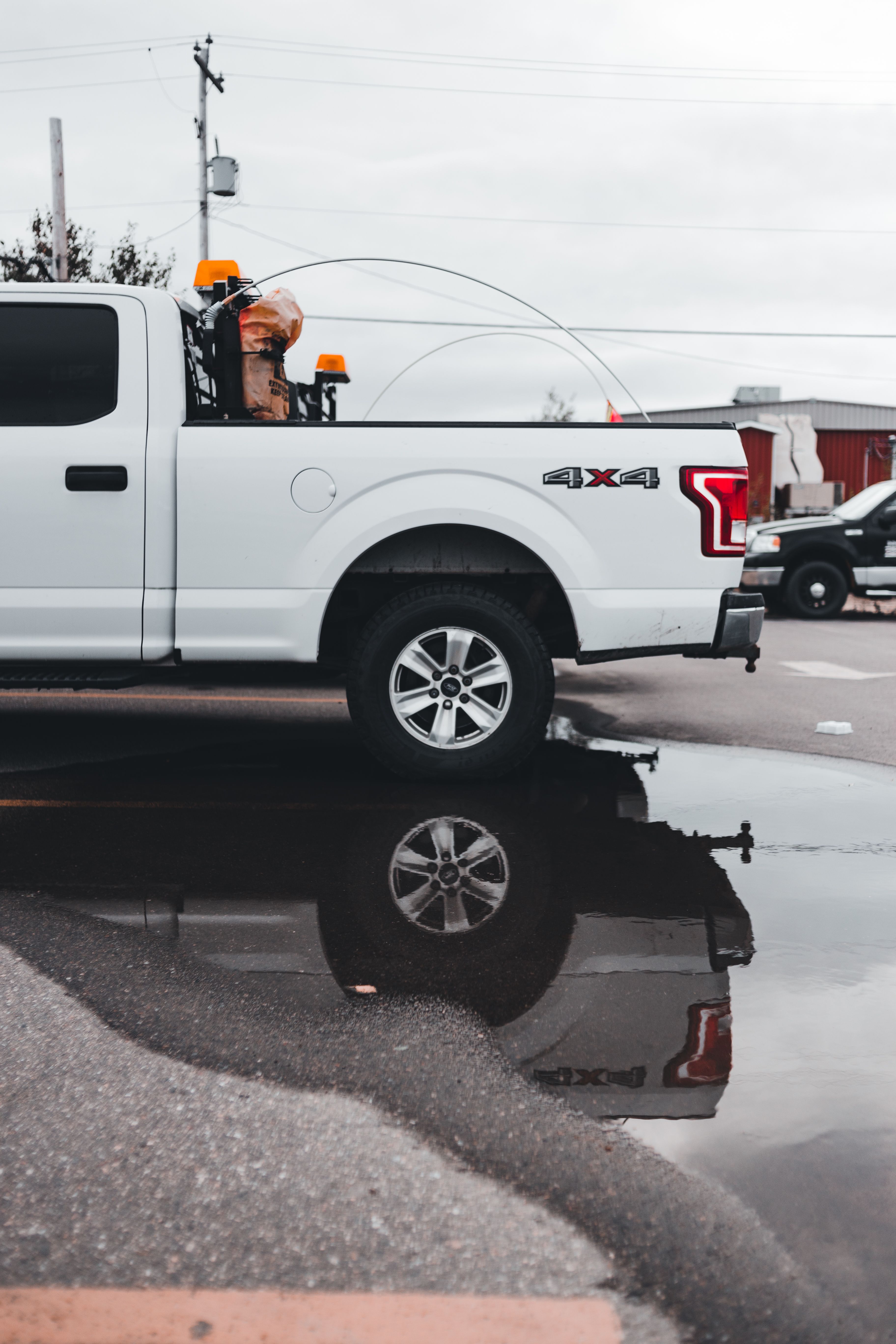 White Pick Up parked on a Puddle · Free Stock Photo