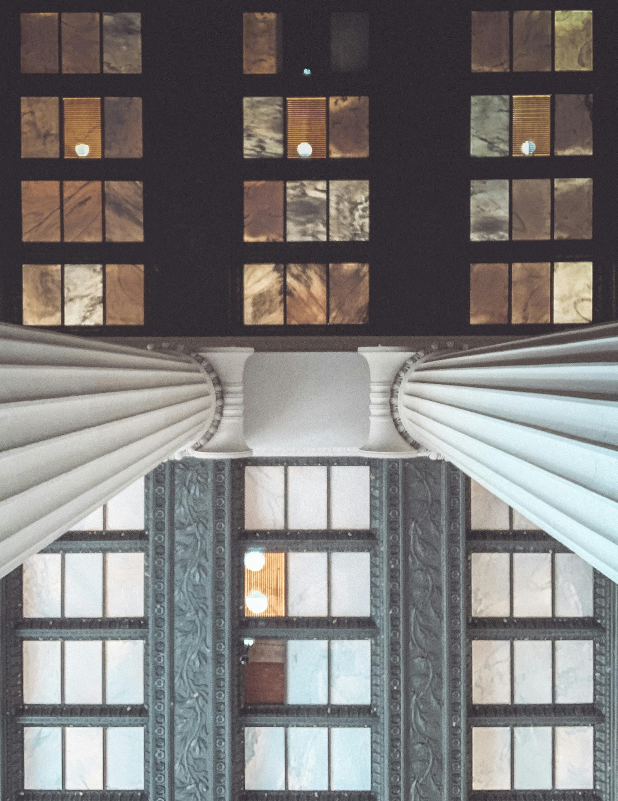 Low Angle Shot of White Pillars and a Glass Ceiling · Free Stock Photo