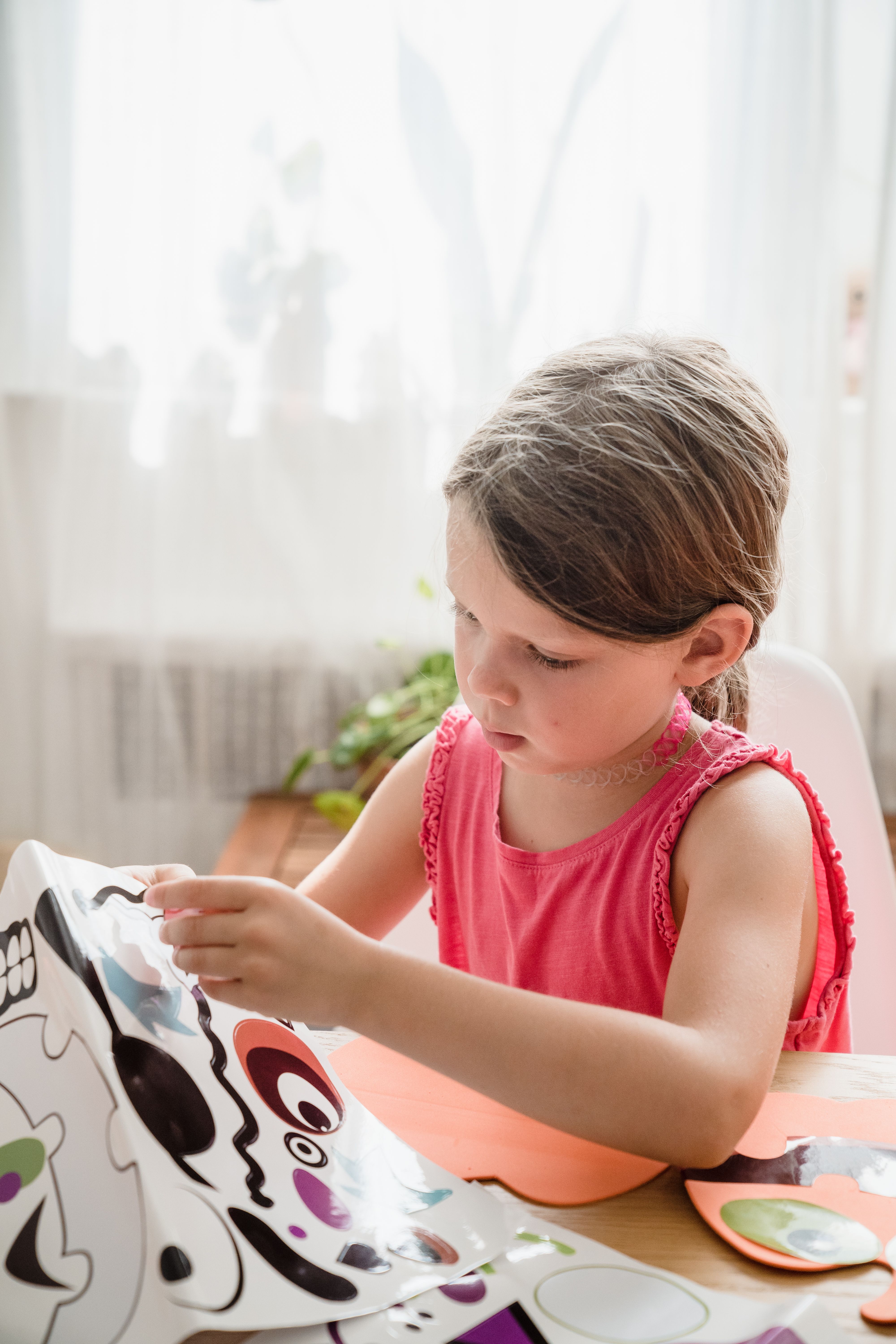 Girl making paper cutouts · Free Stock Photo