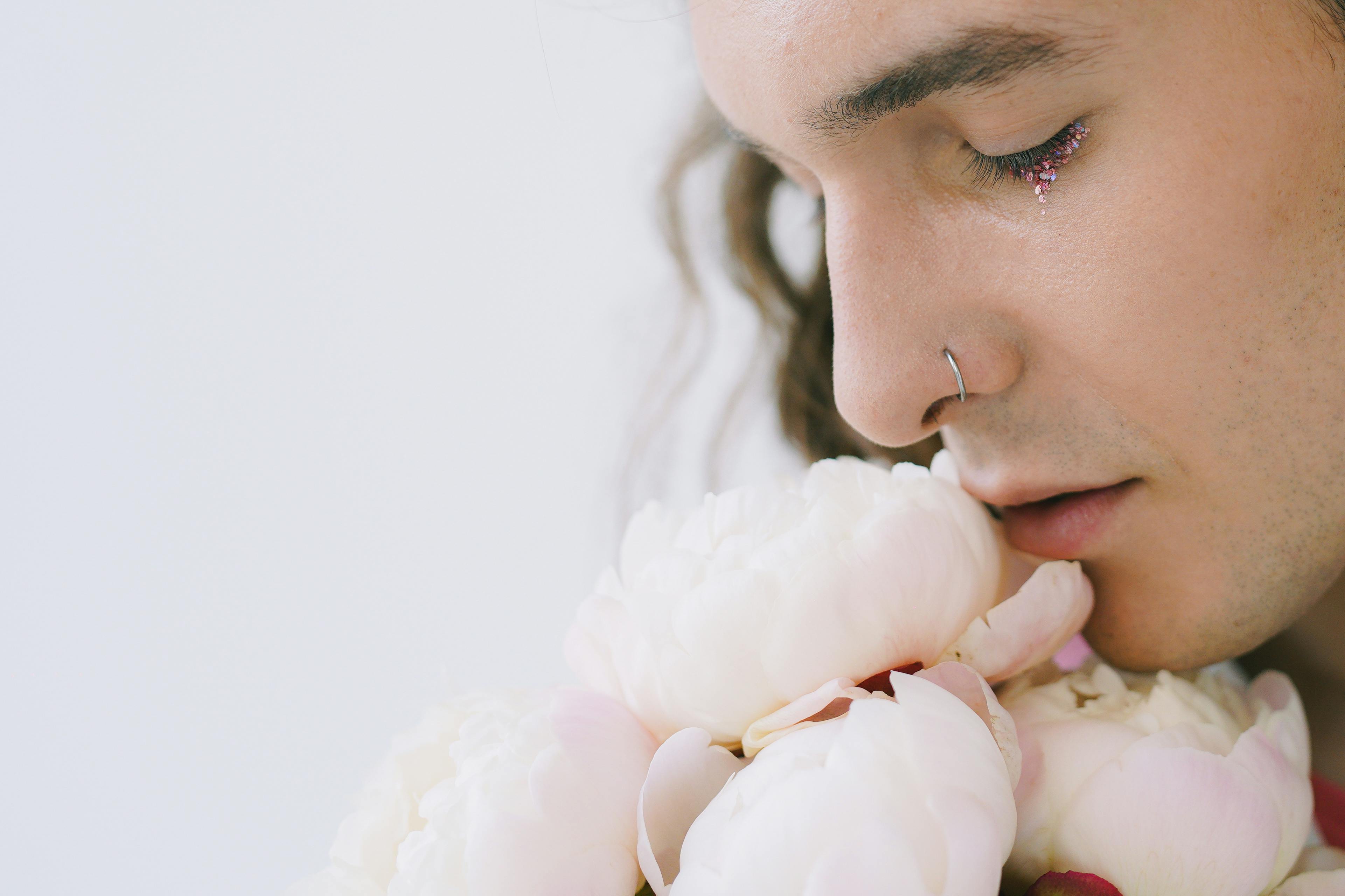 Man smelling flowers · Free Stock Photo