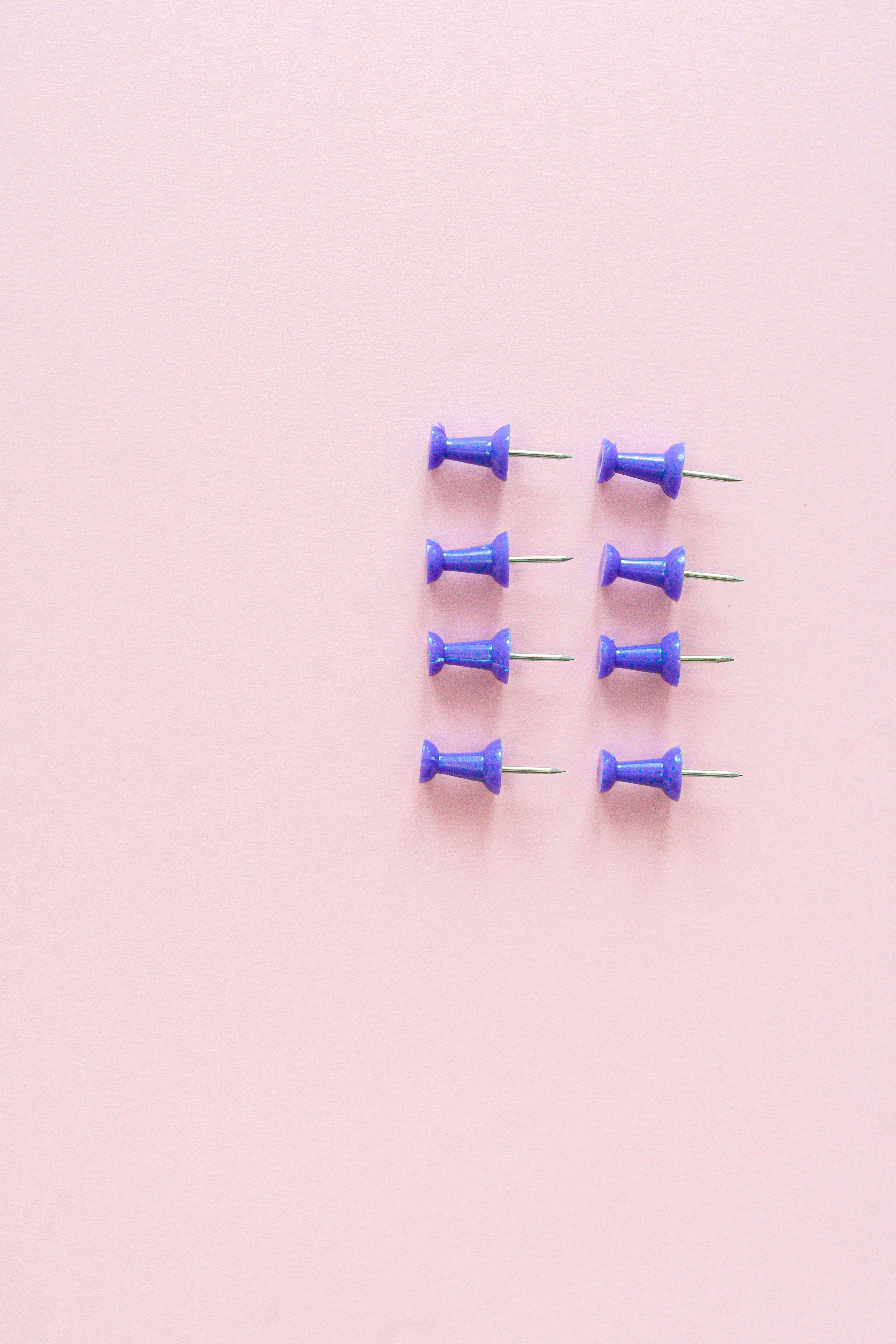 Blue Drawing Pins on Pink Background · Free Stock Photo