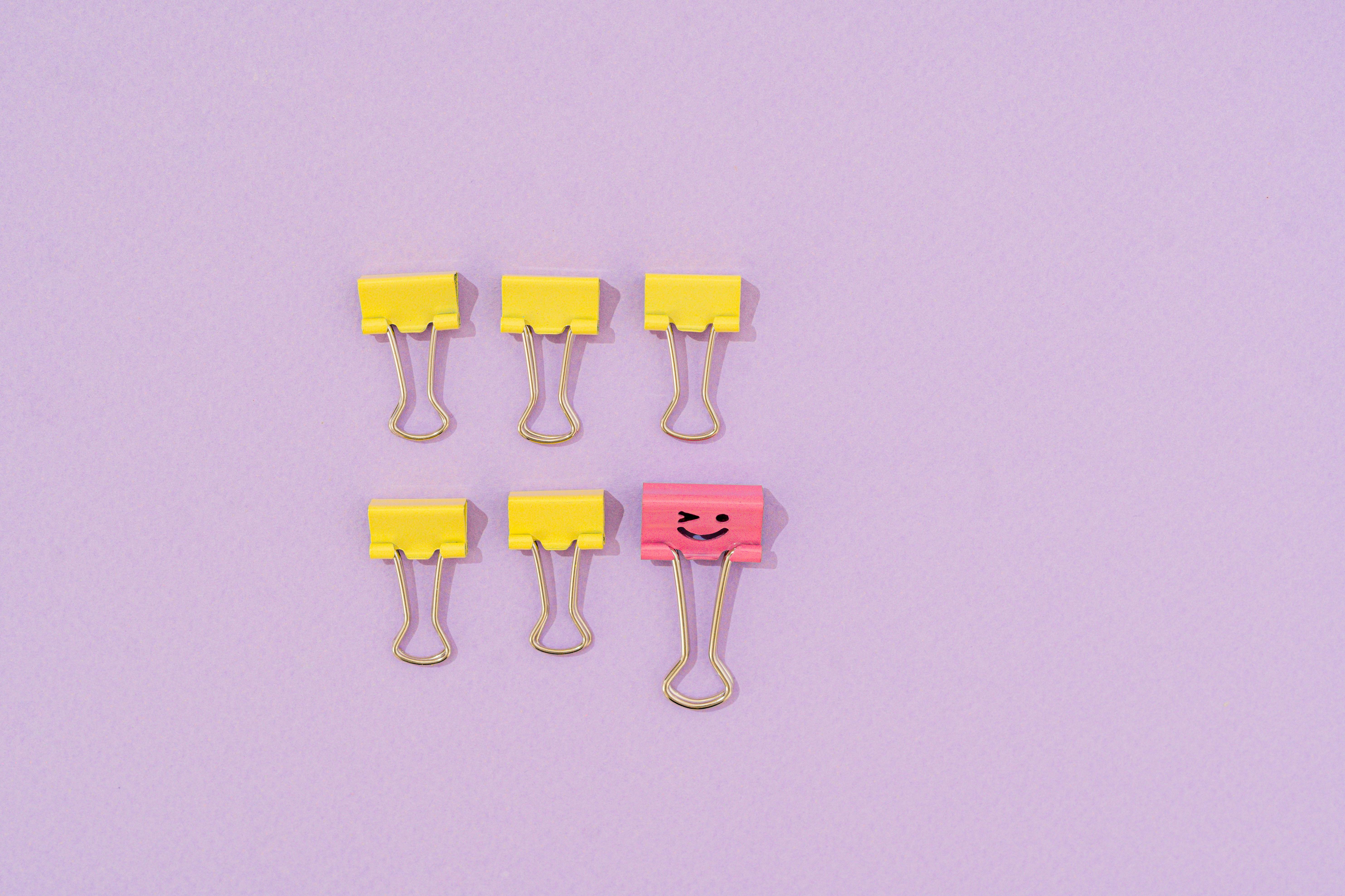 Binder Clips on a Purple Surface · Free Stock Photo