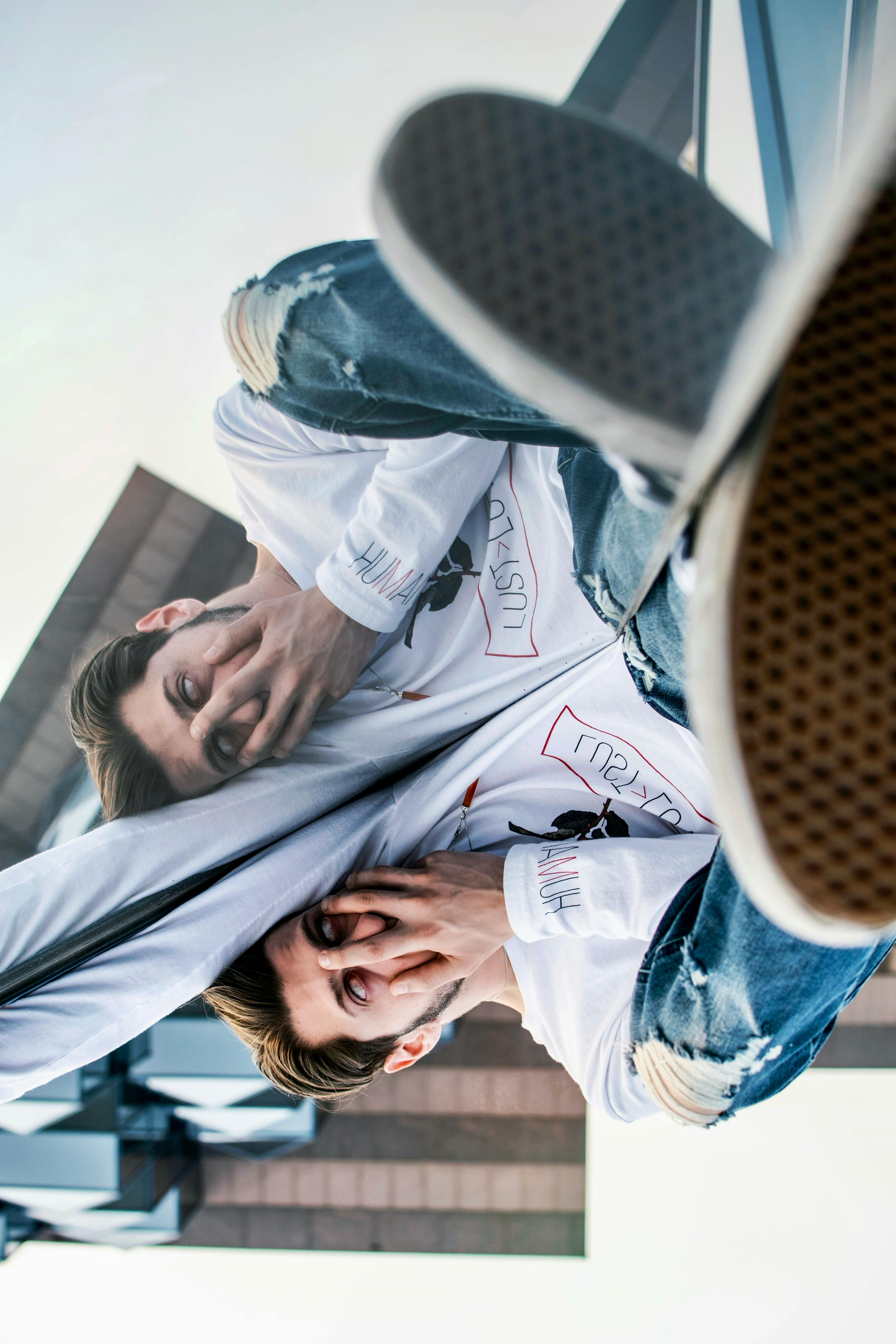 Man Lying and Looking at his Reflection in a Mirror · Free Stock Photo