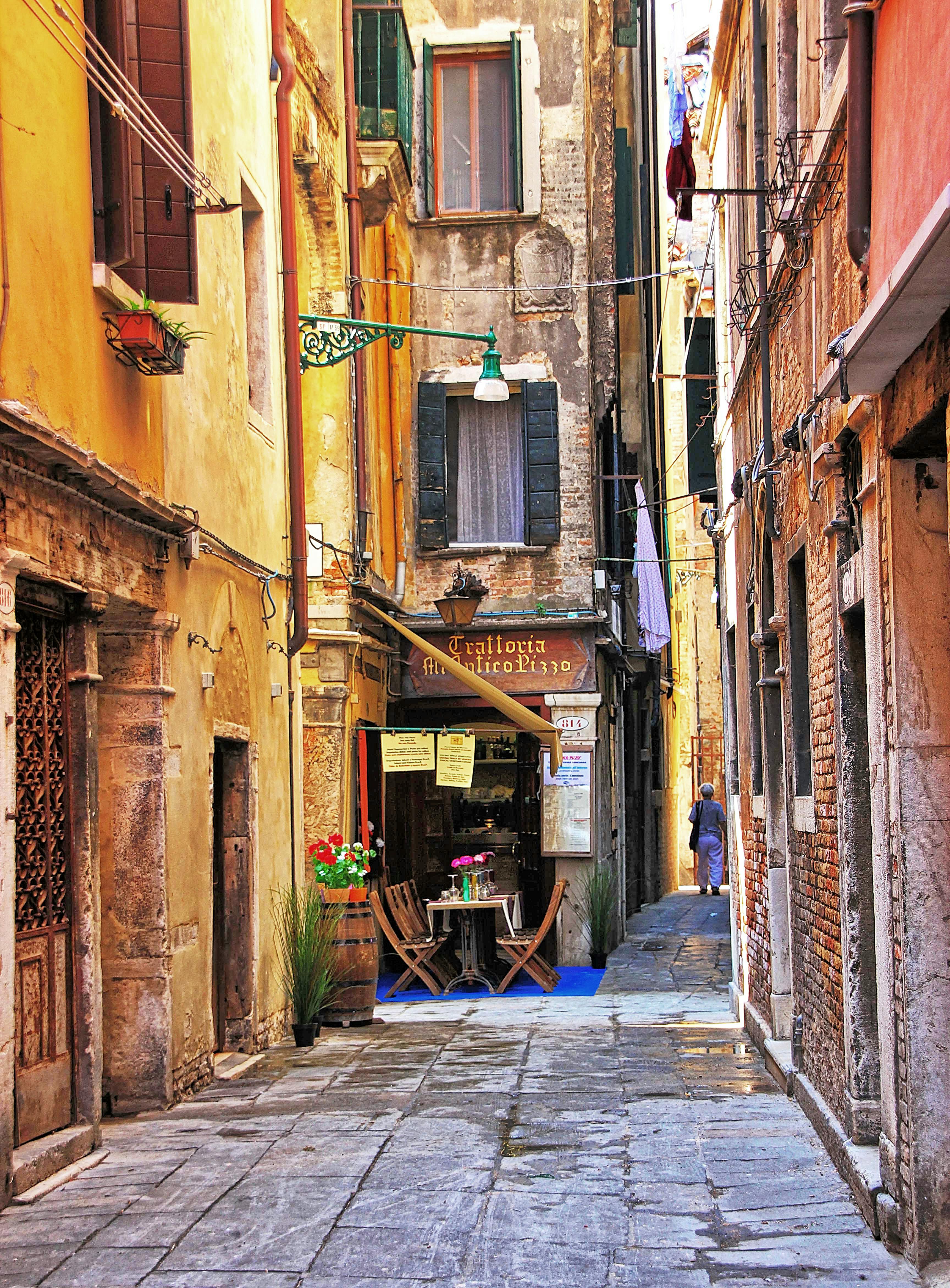 Italian Alley Between Buildings and a Pizzeria · Free Stock Photo