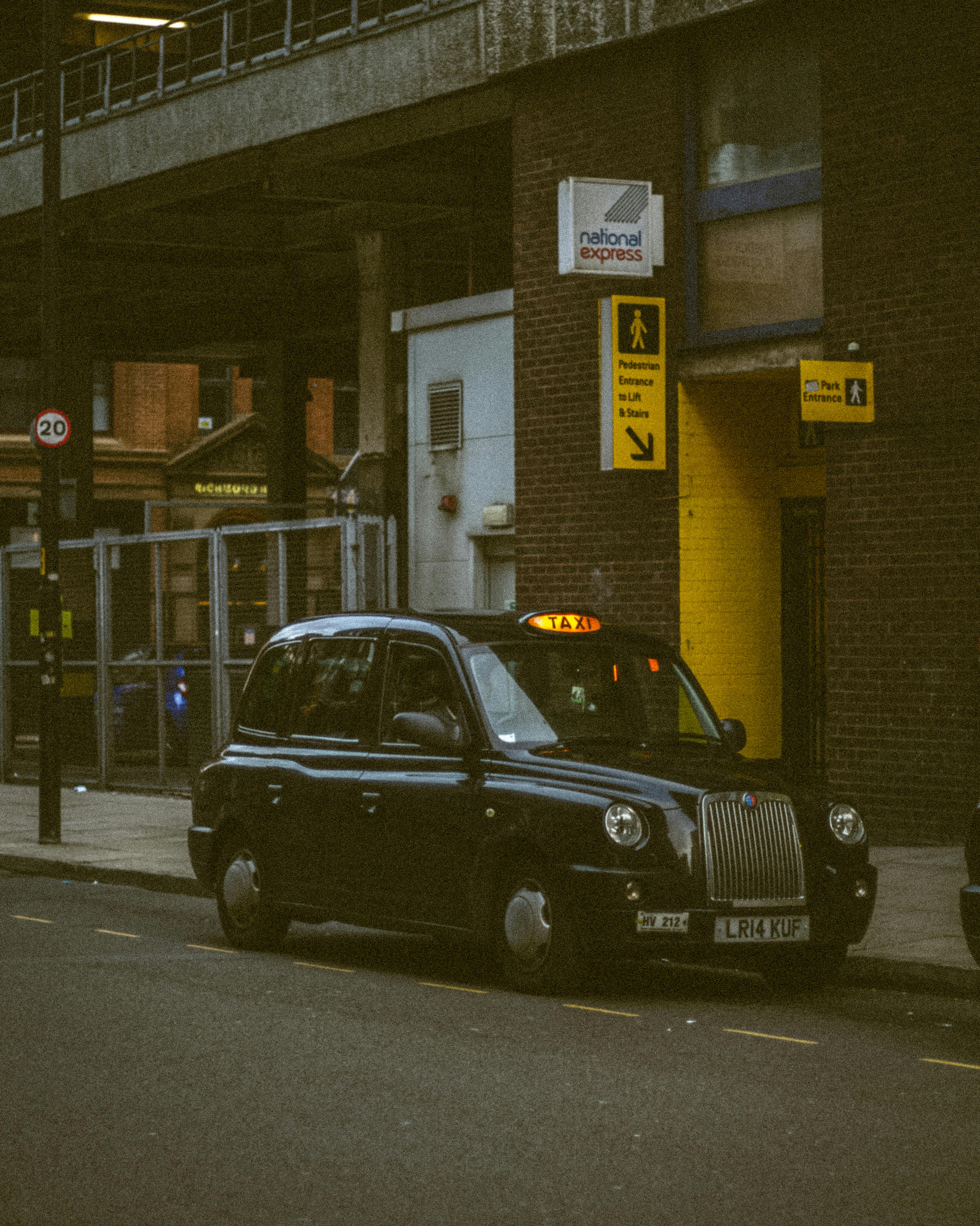 The Black Taxi Parked on the Side of the Road · Free Stock Photo