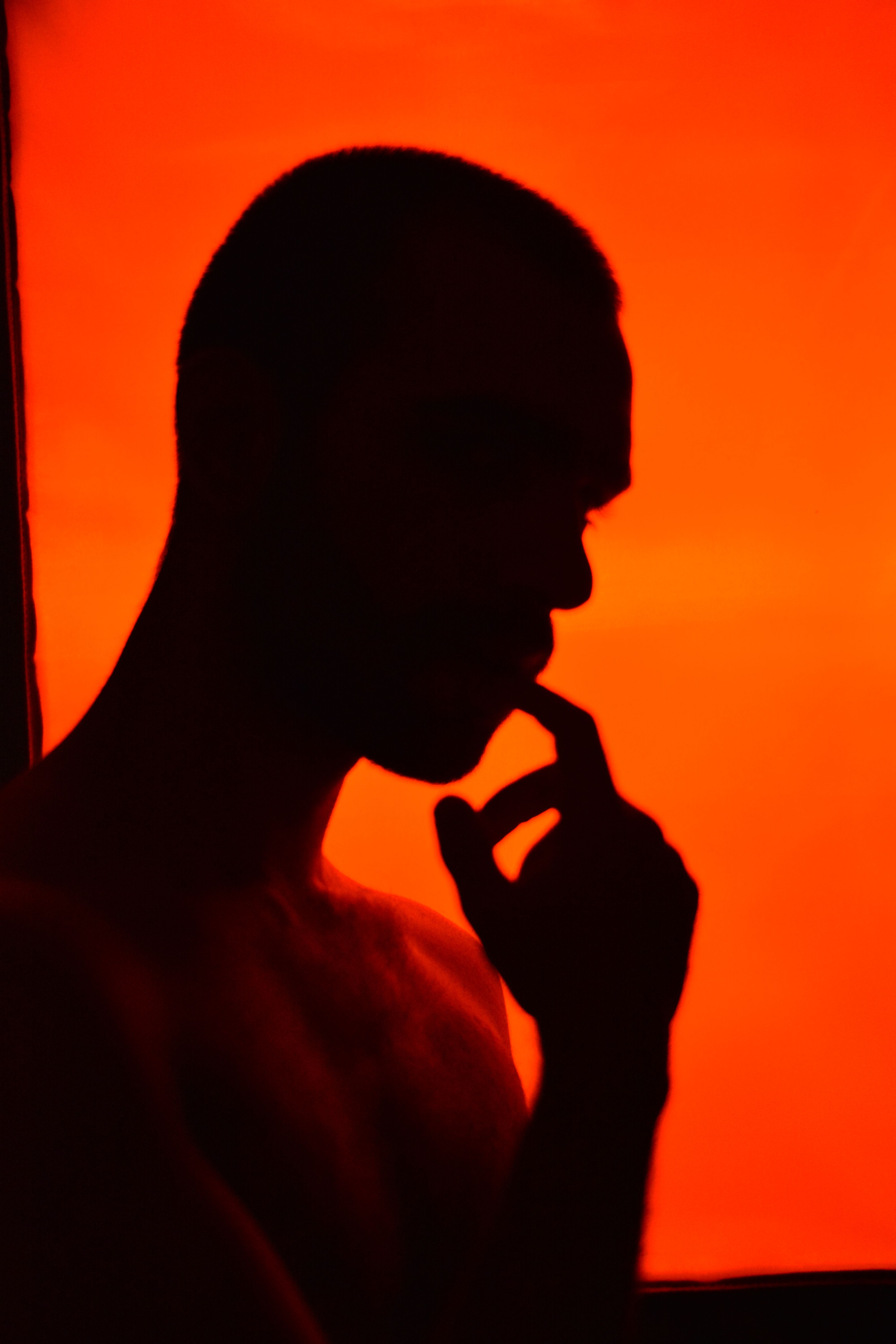 Silhouette of a Man Biting His Finger · Free Stock Photo