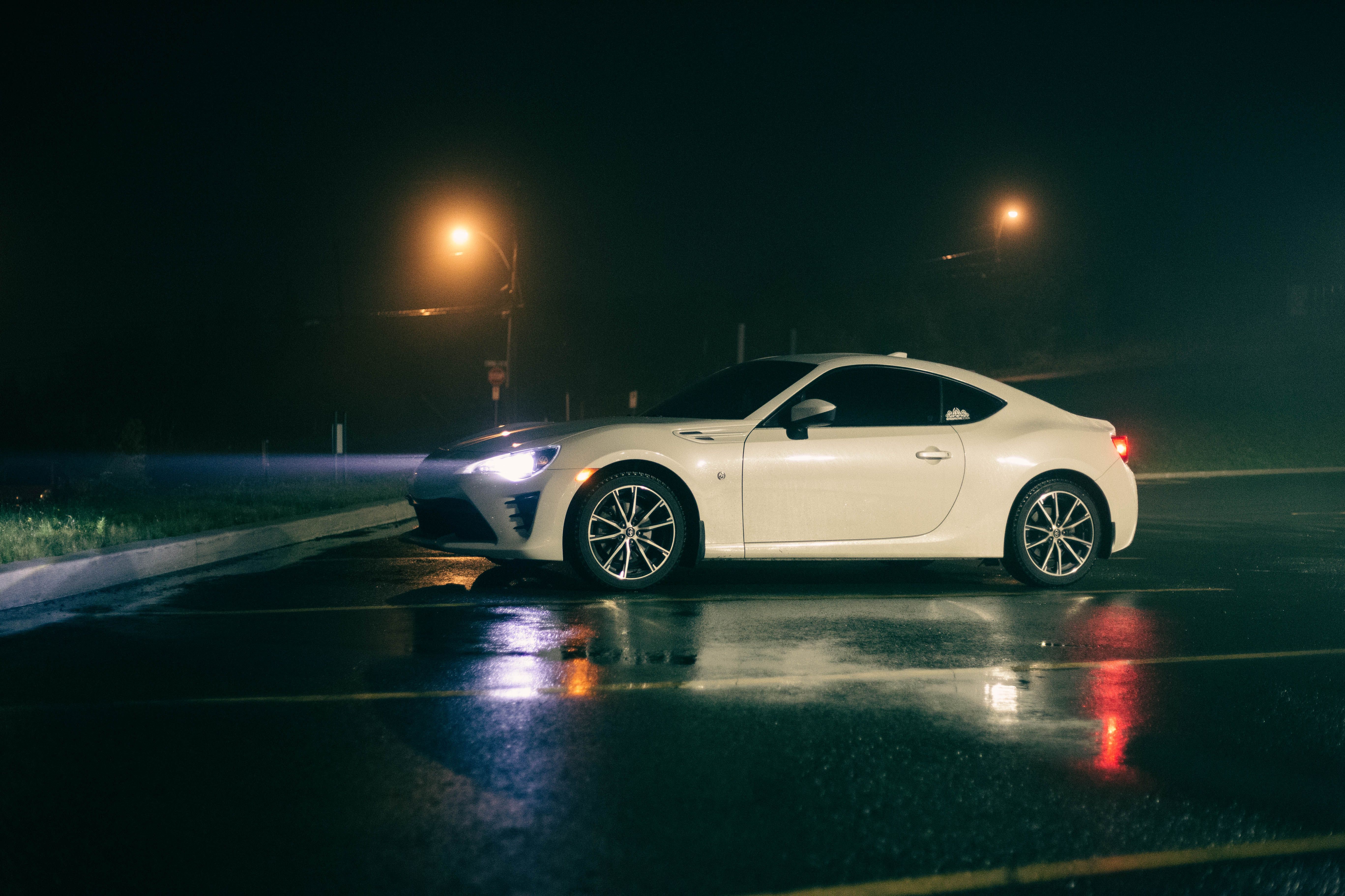 Side View of a Police Car Parked by the Roadside at Night · Free Stock ...