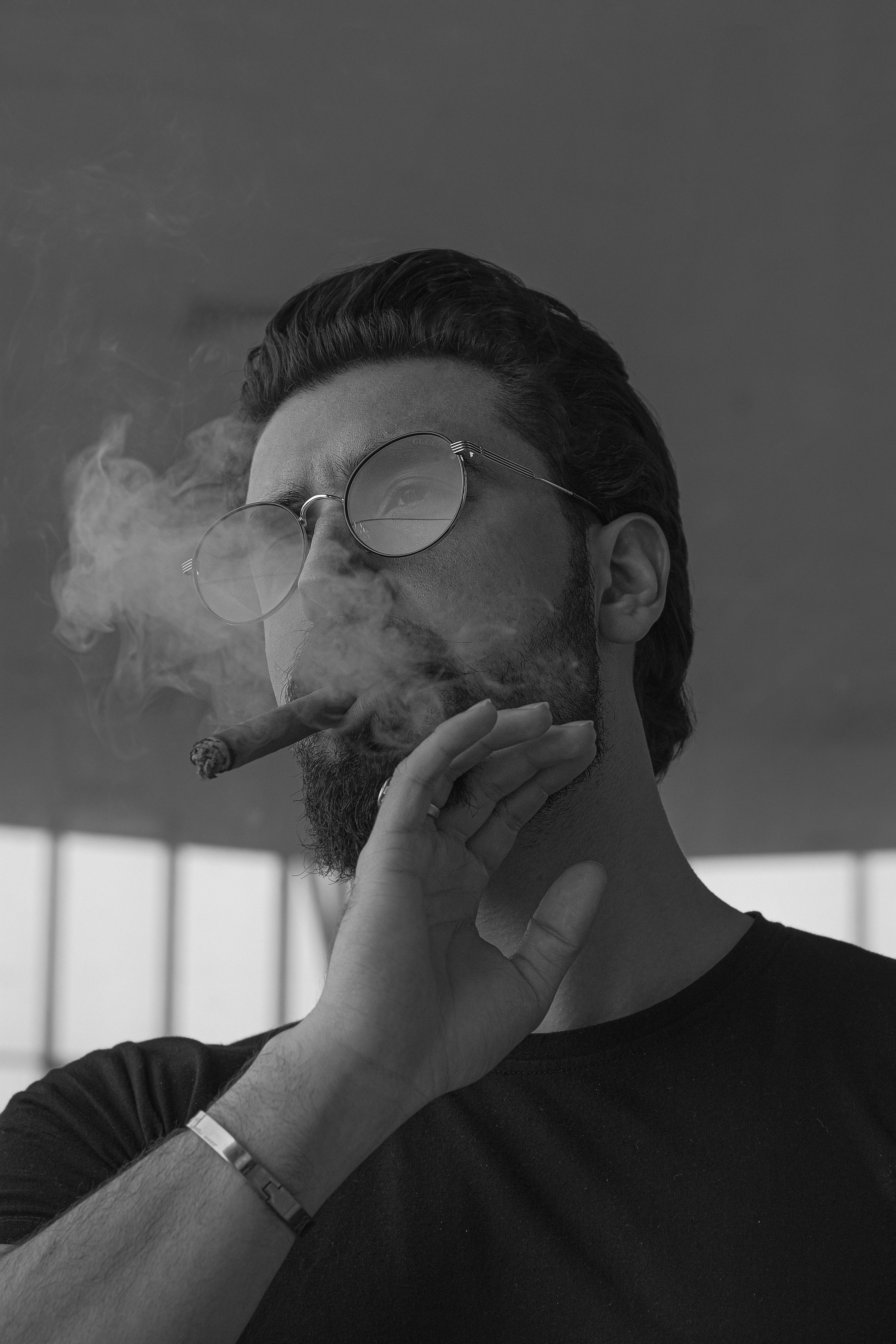 Portrait of a Man Smoking a Cigar · Free Stock Photo