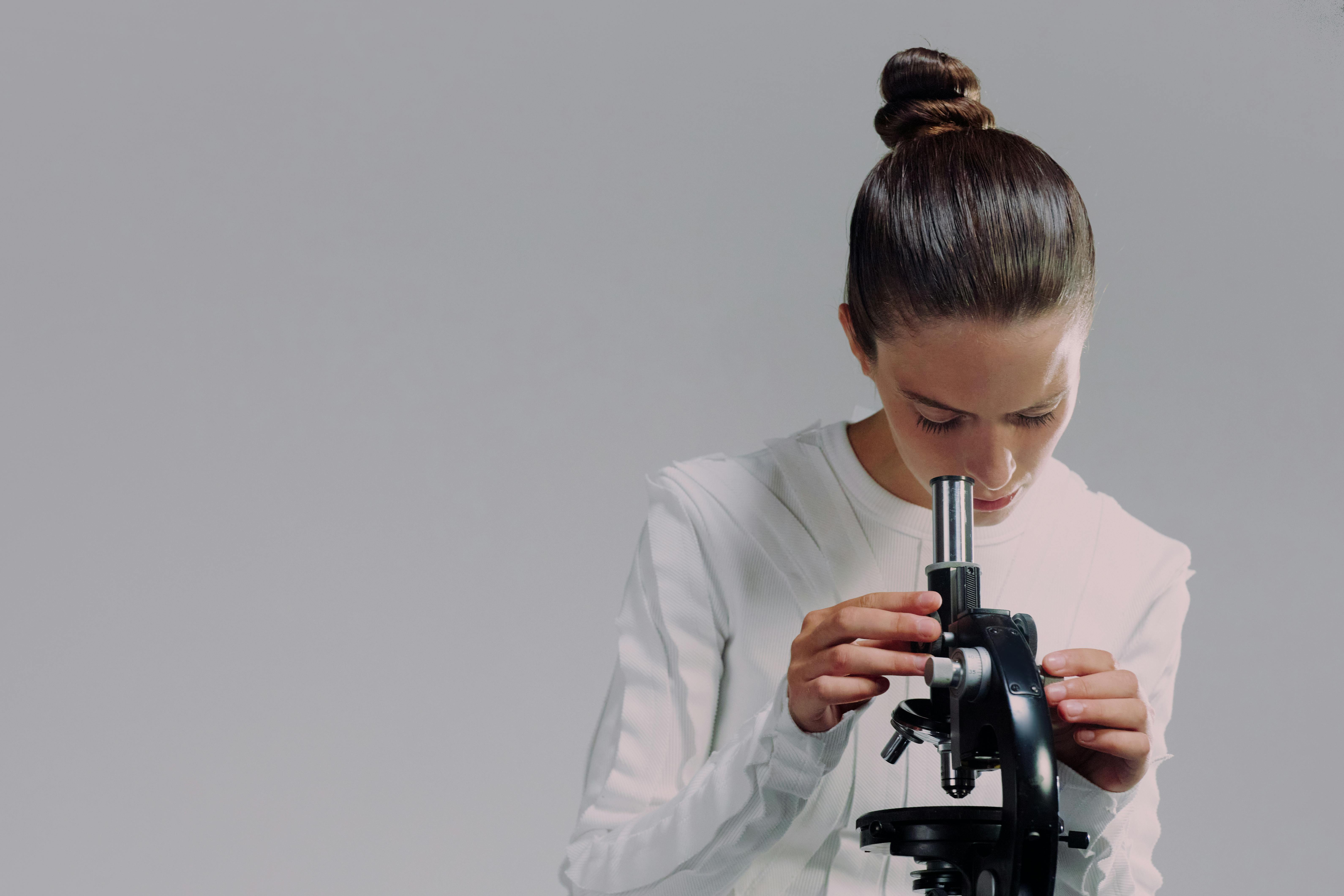 Portrait of woman using microscope · Free Stock Photo
