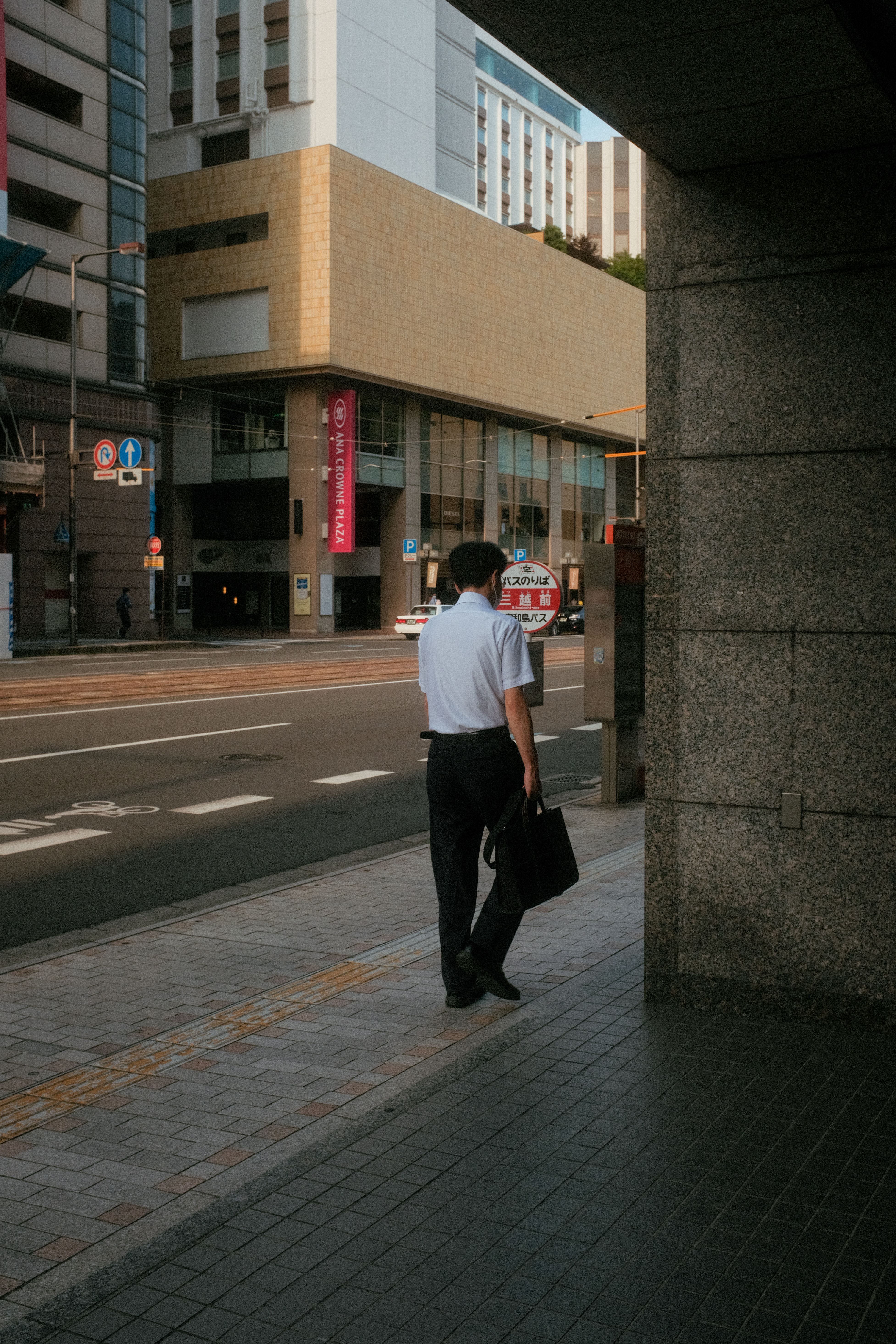 Civilian Walking on a Sidewalk · Free Stock Photo