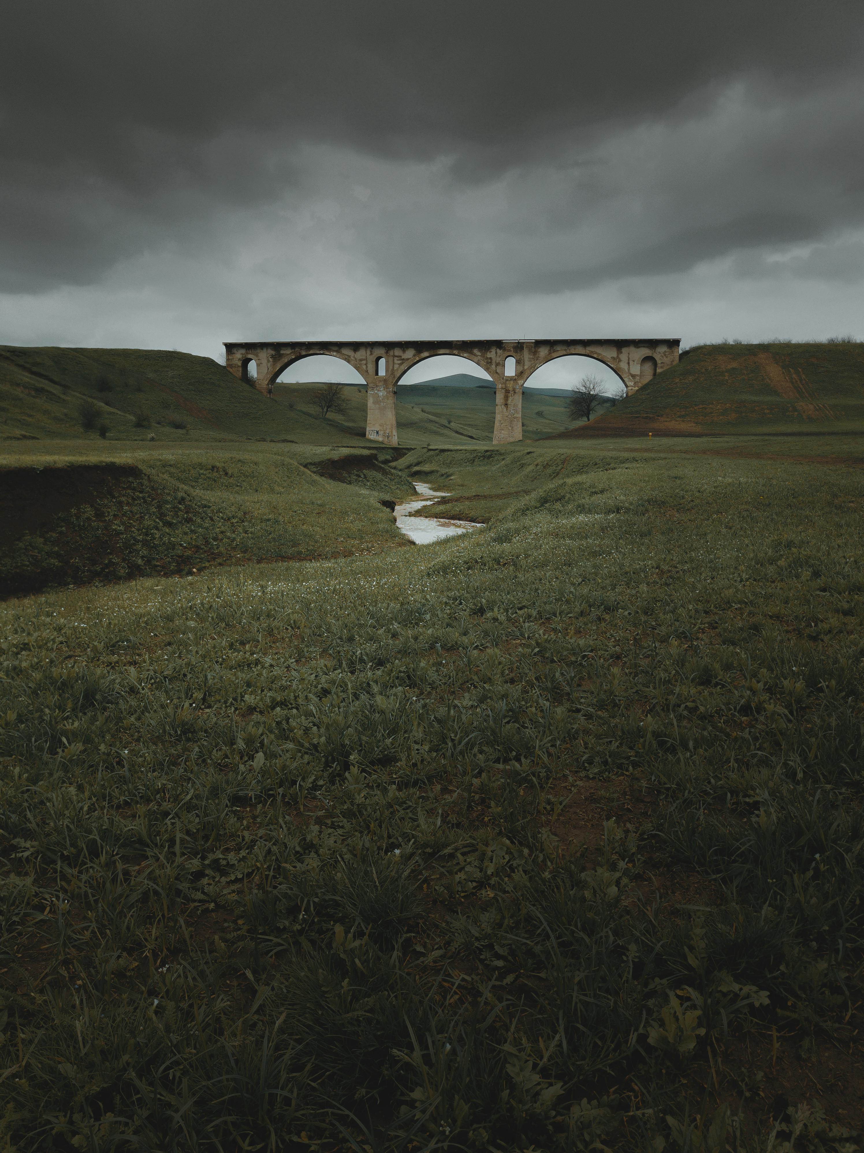 Old Bridge over River in Open Field · Free Stock Photo