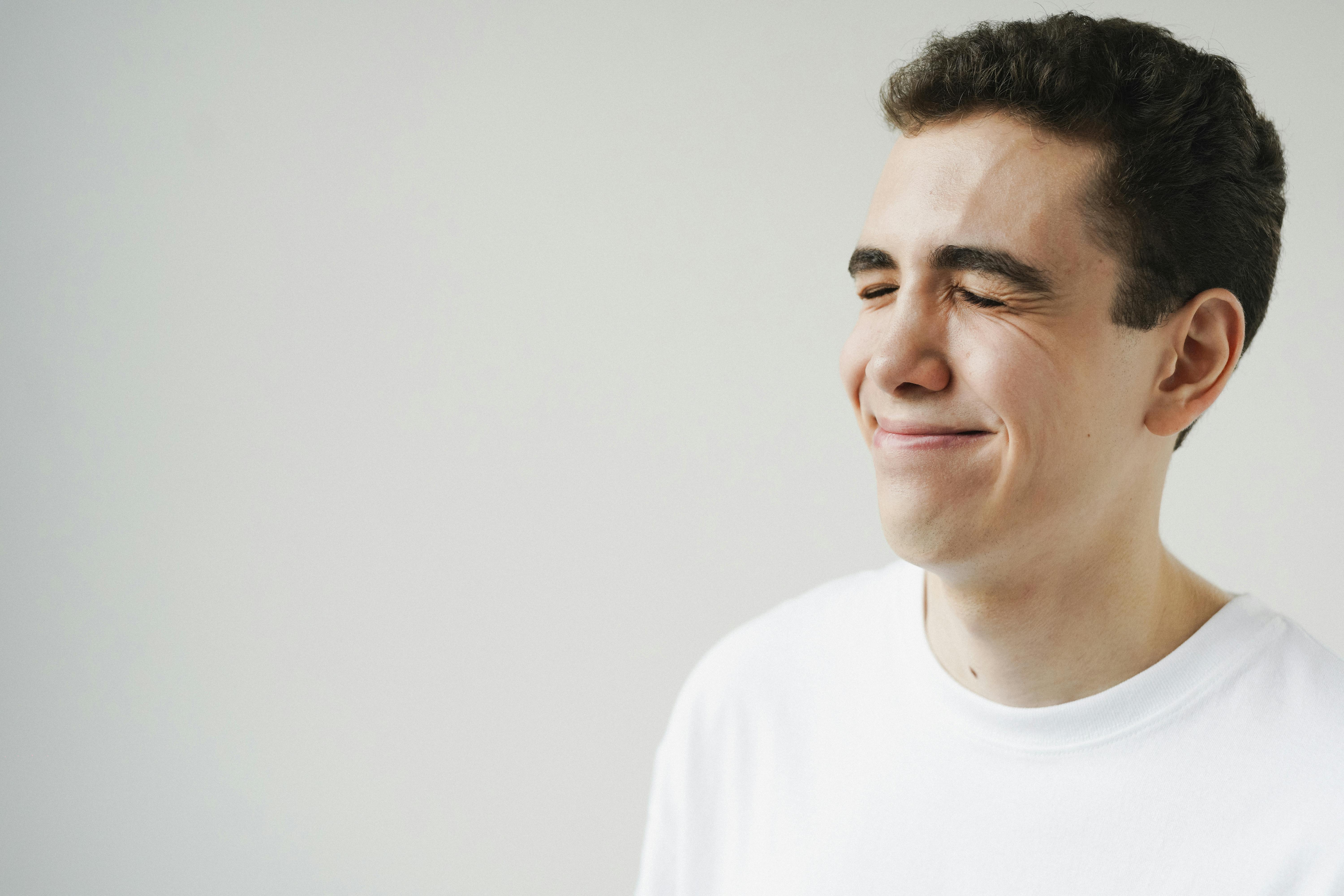 Young Man Smiling with His Eyes Shut · Free Stock Photo