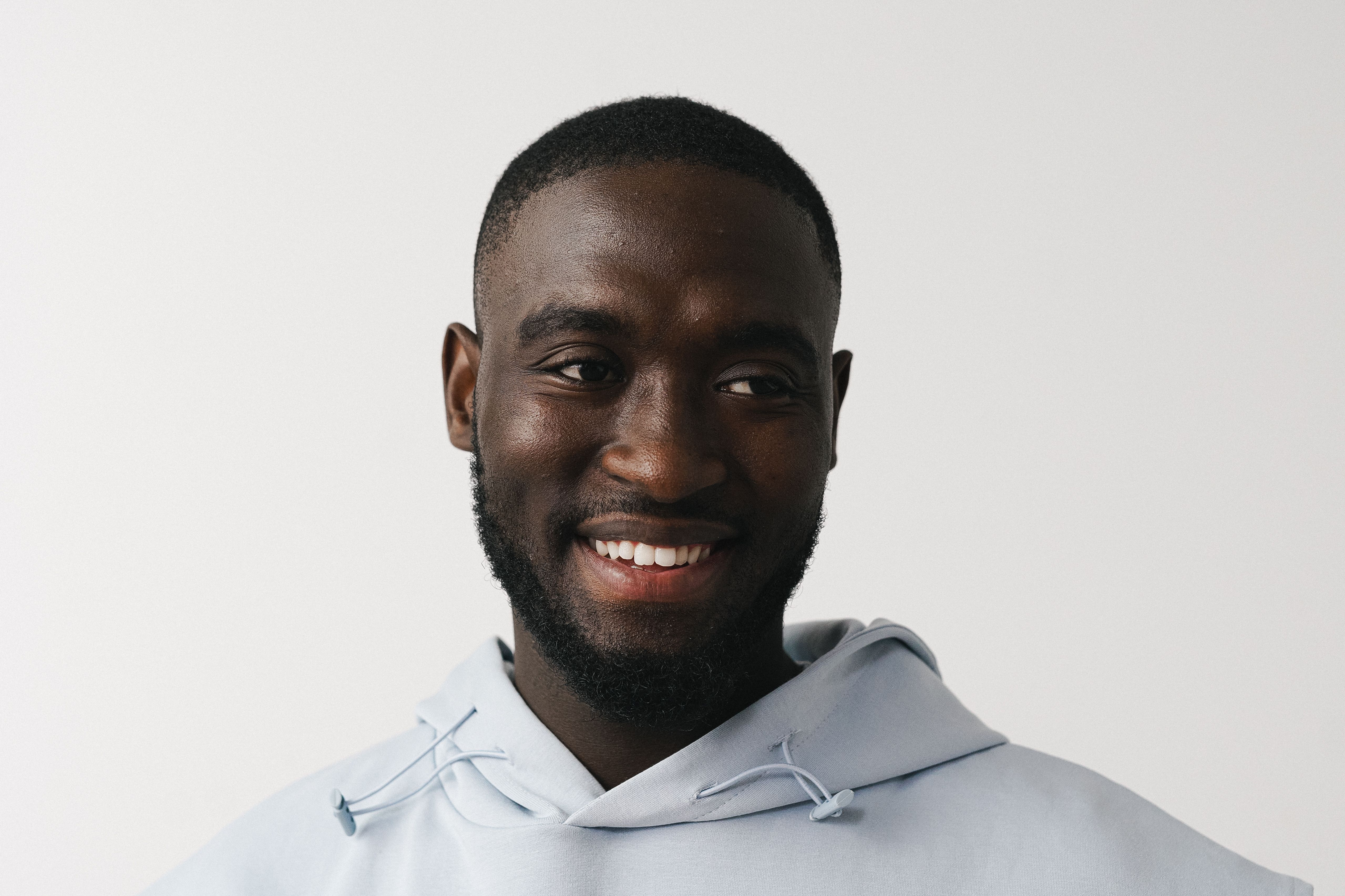 A Portrait of a Man Wearing a Hoodie · Free Stock Photo