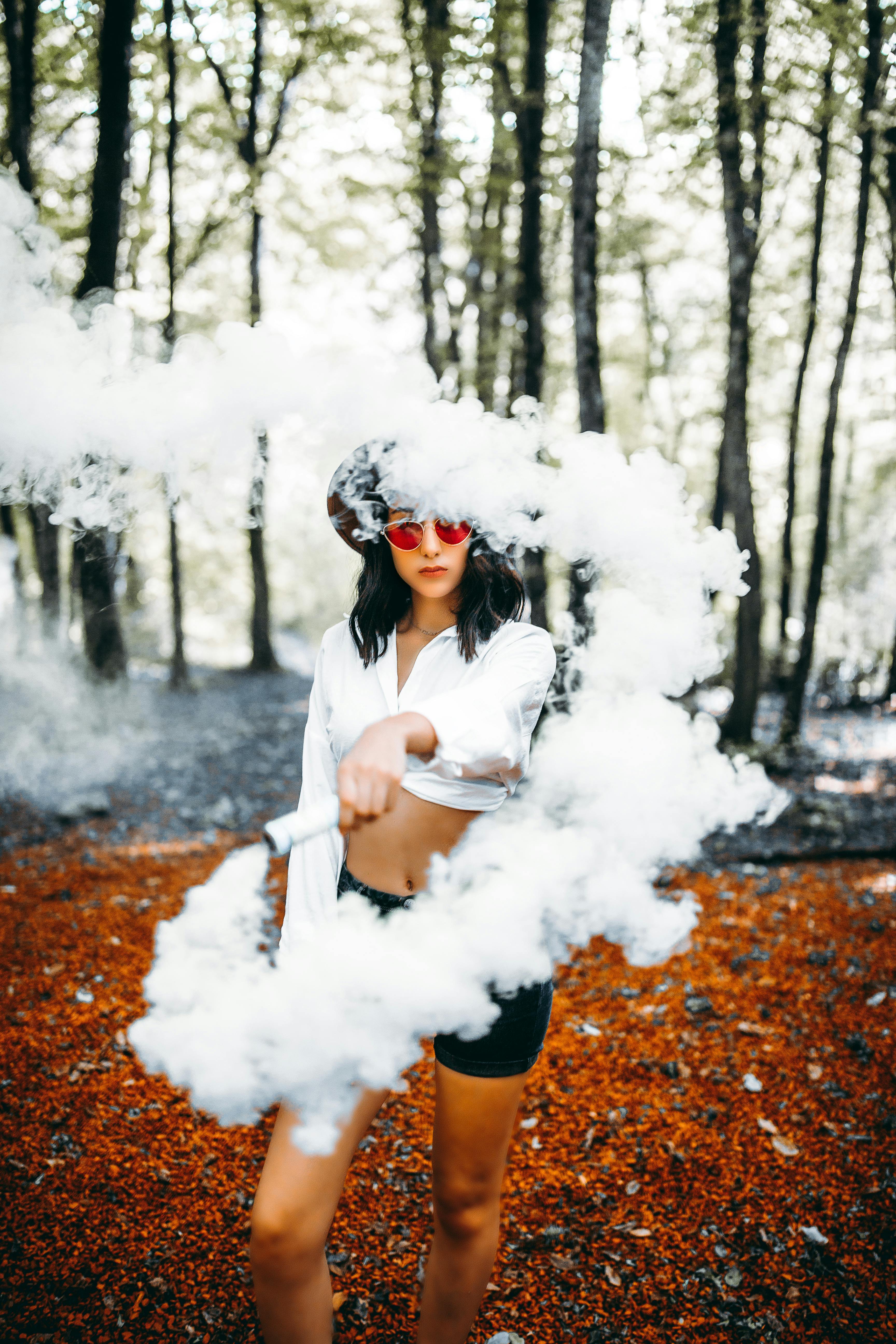 Woman Holding Blue Smoke Flare · Free Stock Photo