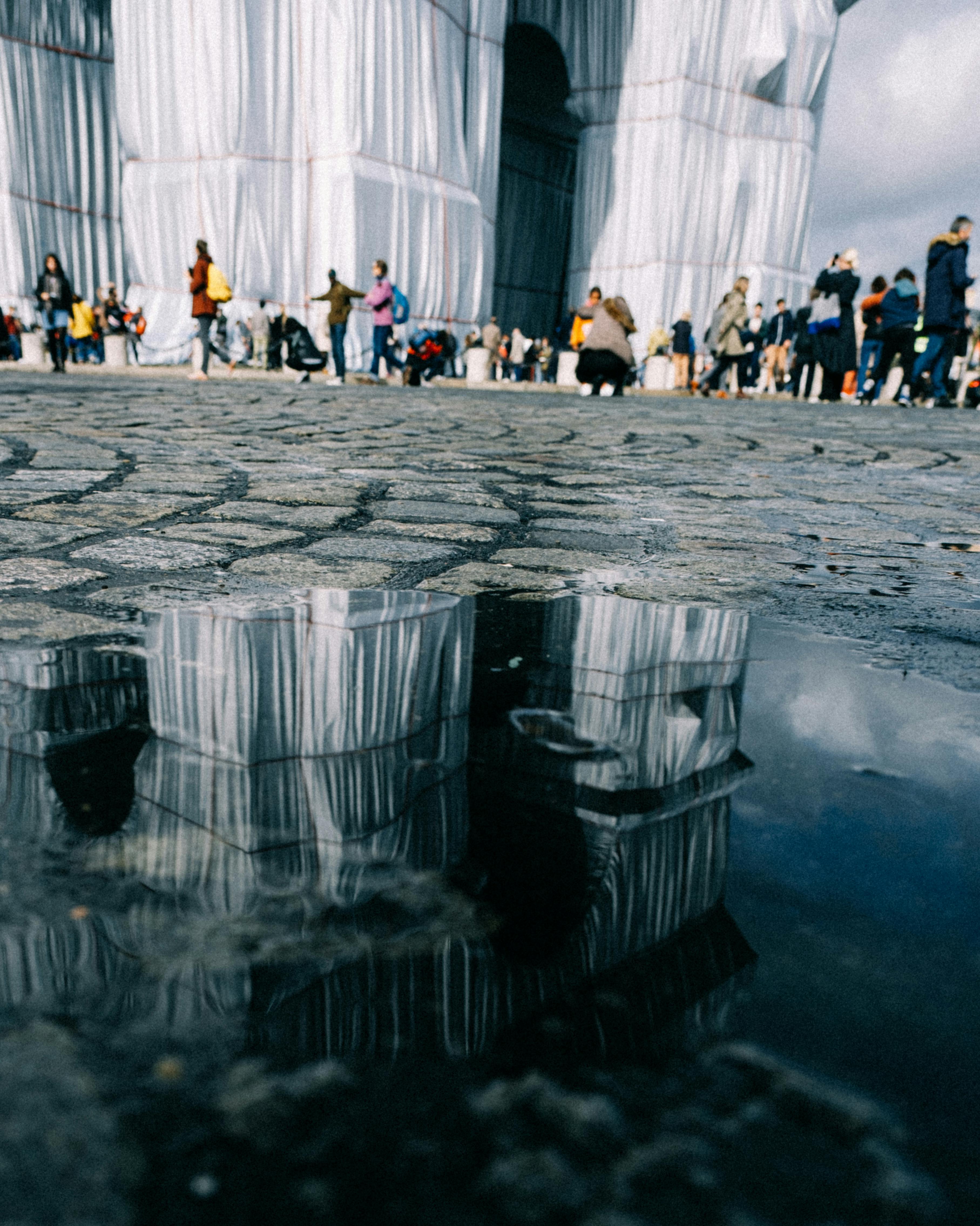 Reflection in Puddle of Photographer and Urban Building Facade · Free ...