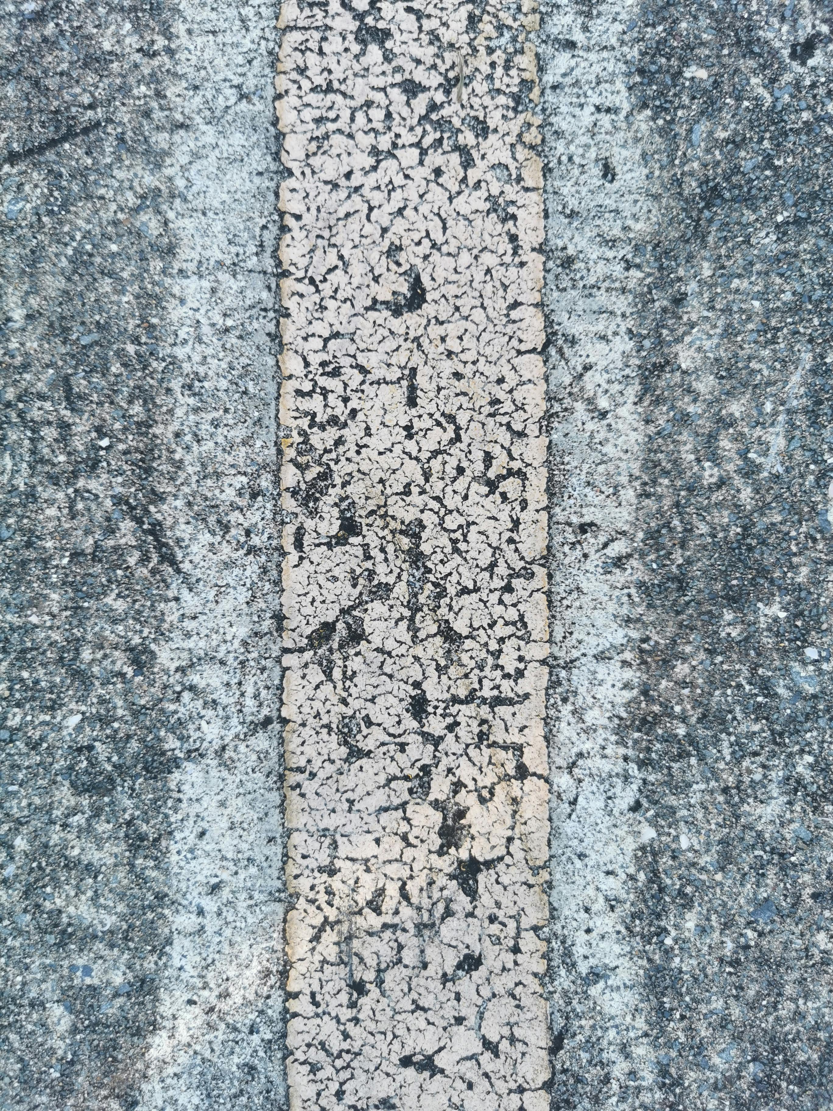 Closeup of Weathered Road Marking with Rough Texture · Free Stock Photo