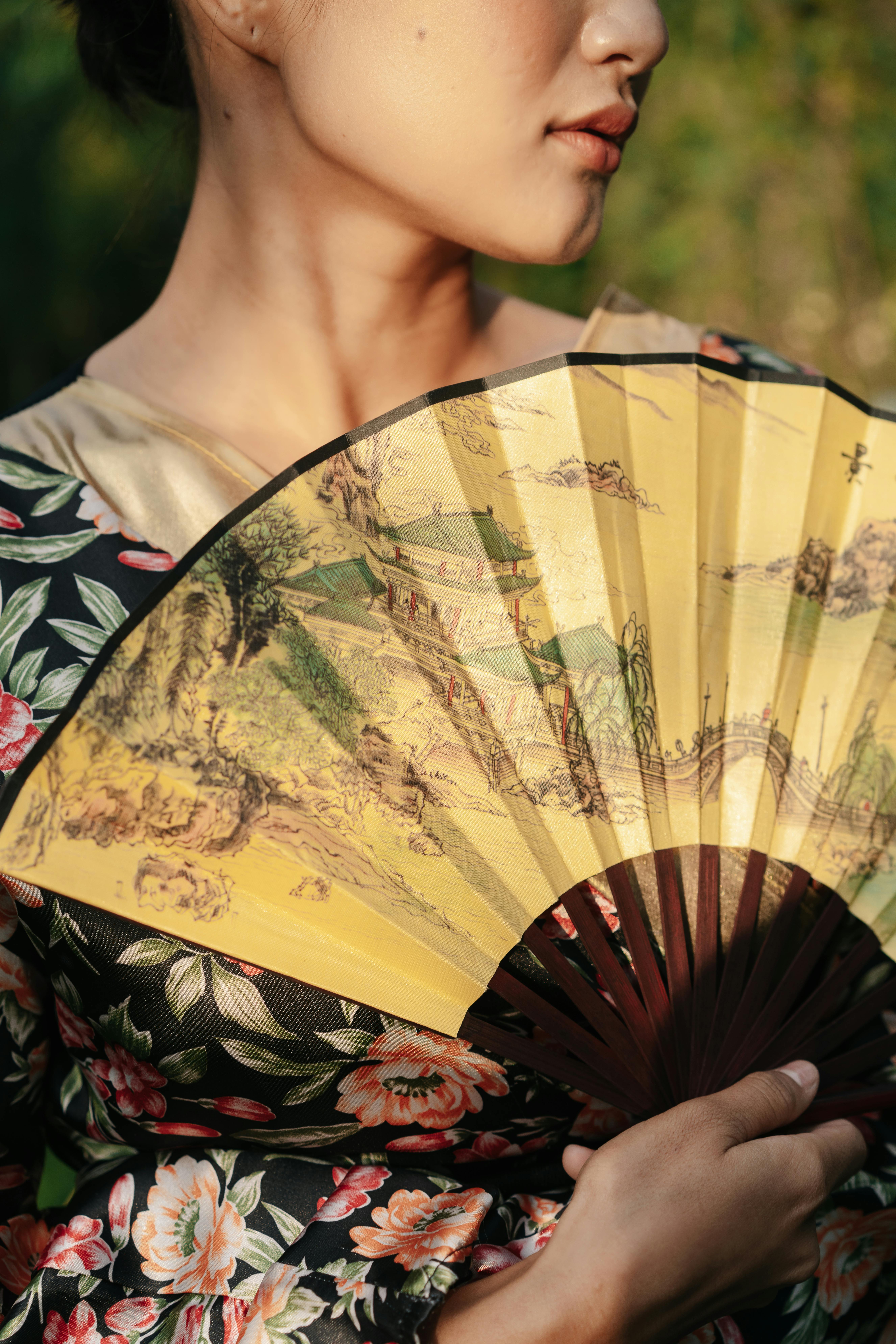 Close Up Photo of a Woman Holding a Fan · Free Stock Photo