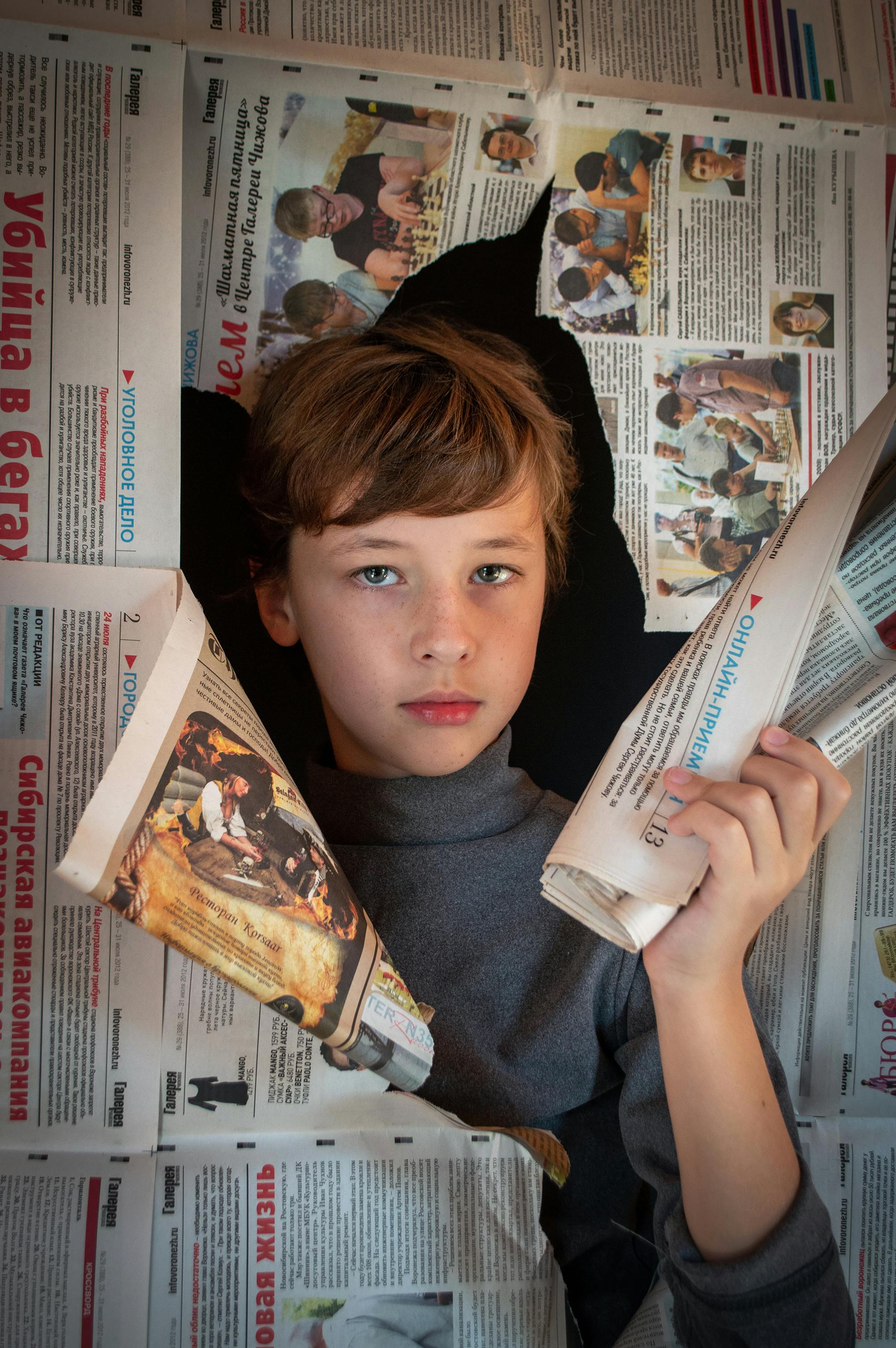A Boy Holding a Poster · Free Stock Photo