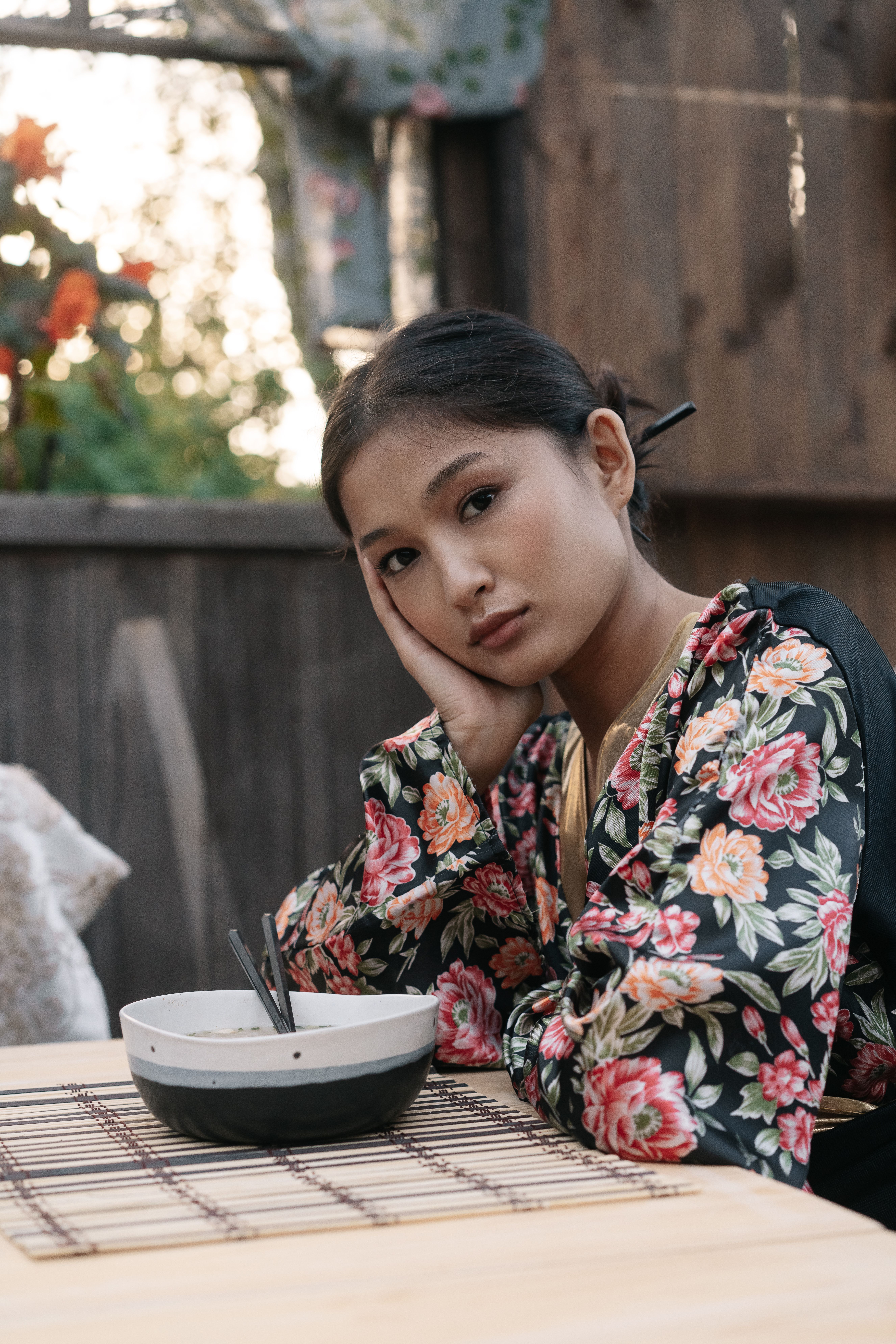 Young Woman at the Table Eating with Chopsticks · Free Stock Photo