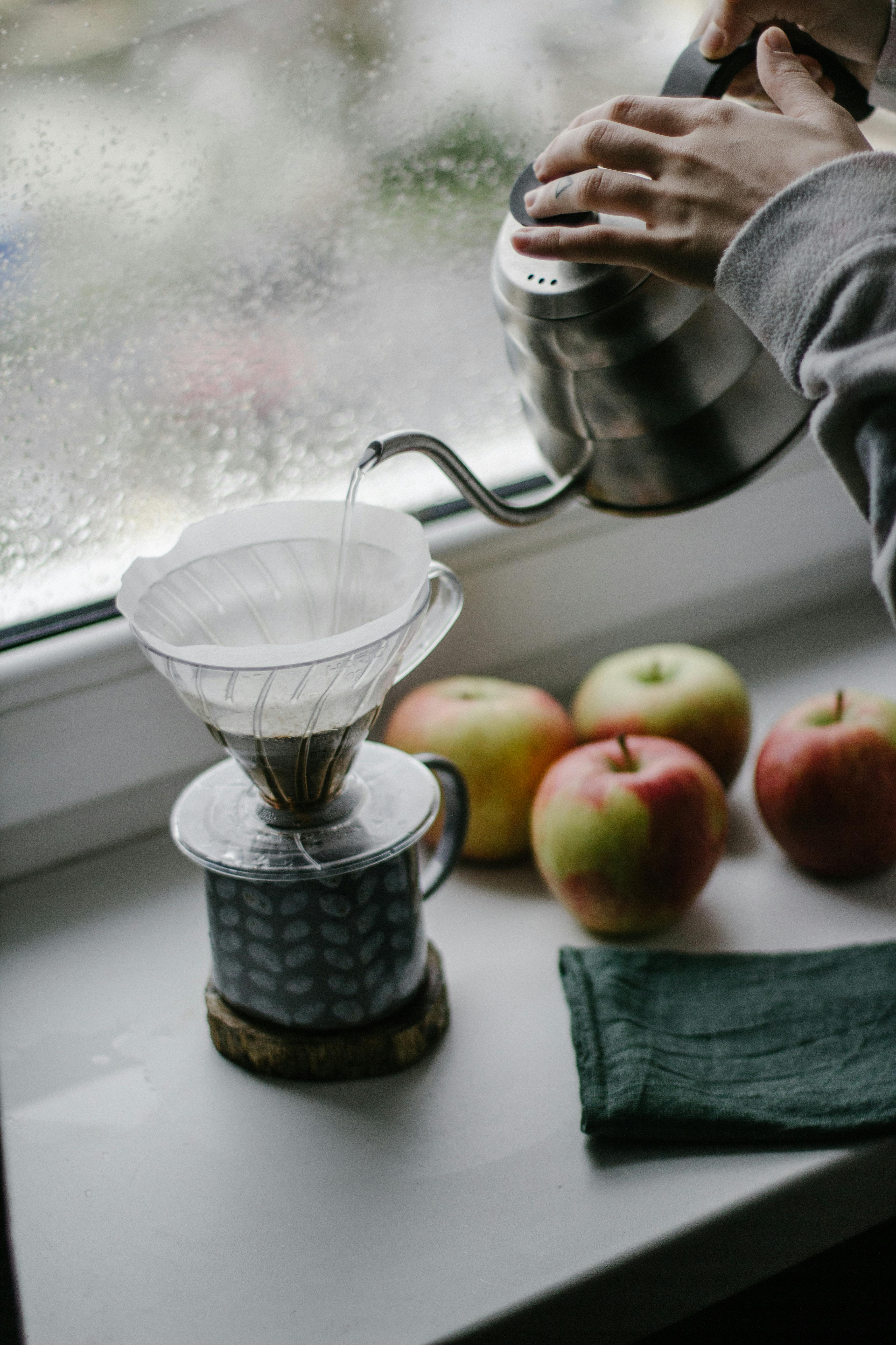 Pouring Ground Coffee into the AeroPress Coffeemaker · Free Stock Photo