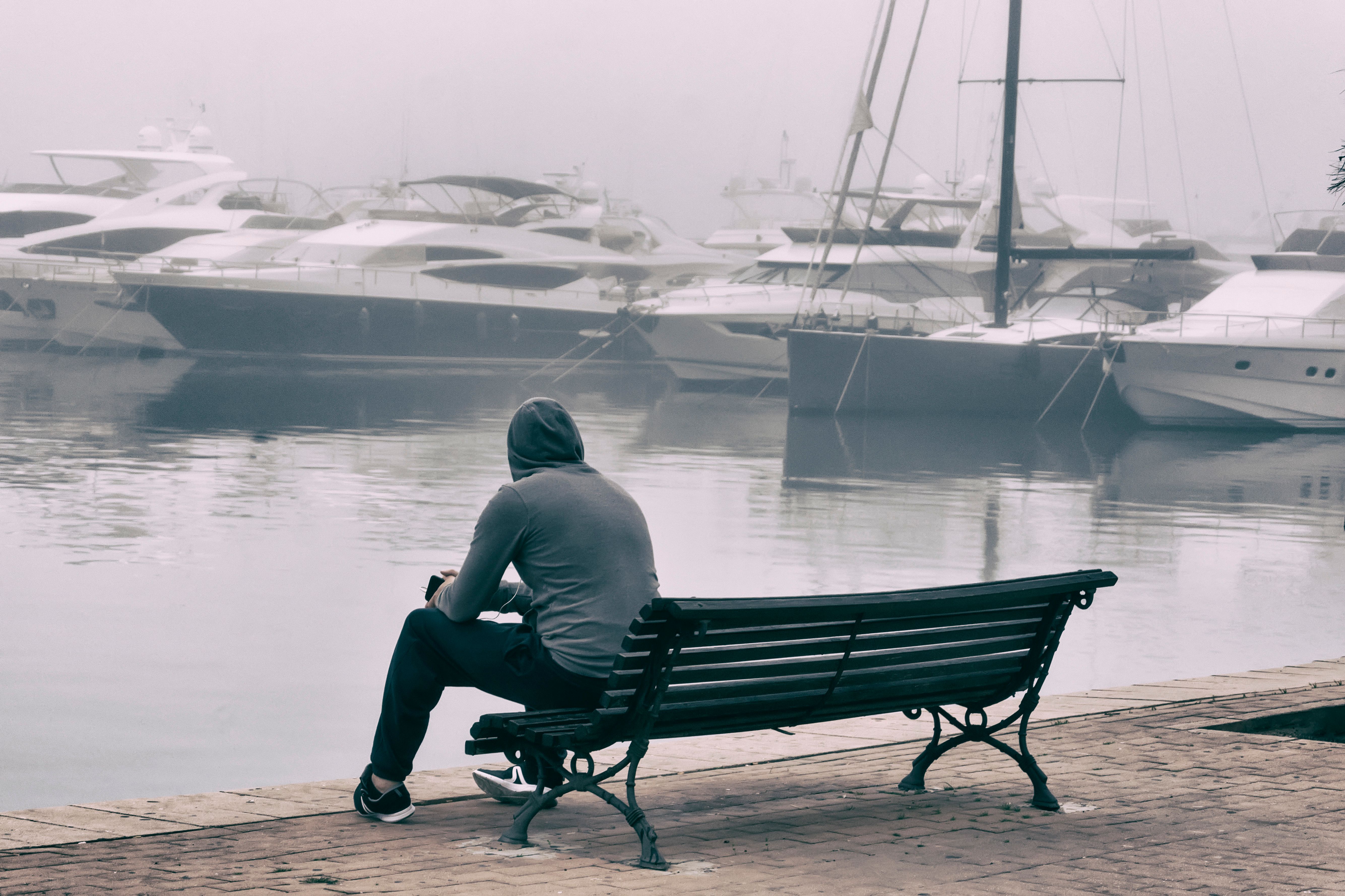 Person Sitting On Dock · Free Stock Photo