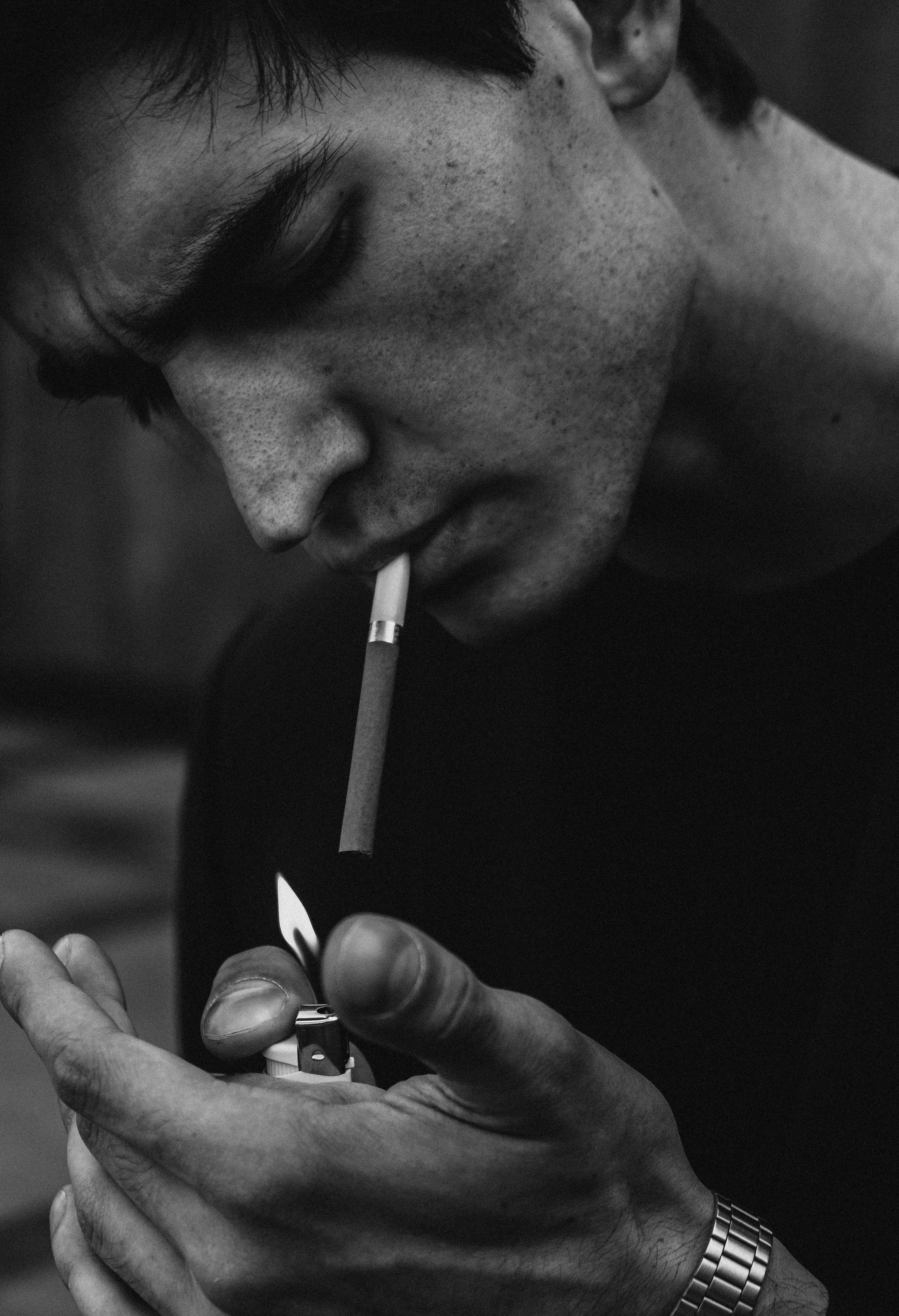 Female rocker smoking in underground parking · Free Stock Photo