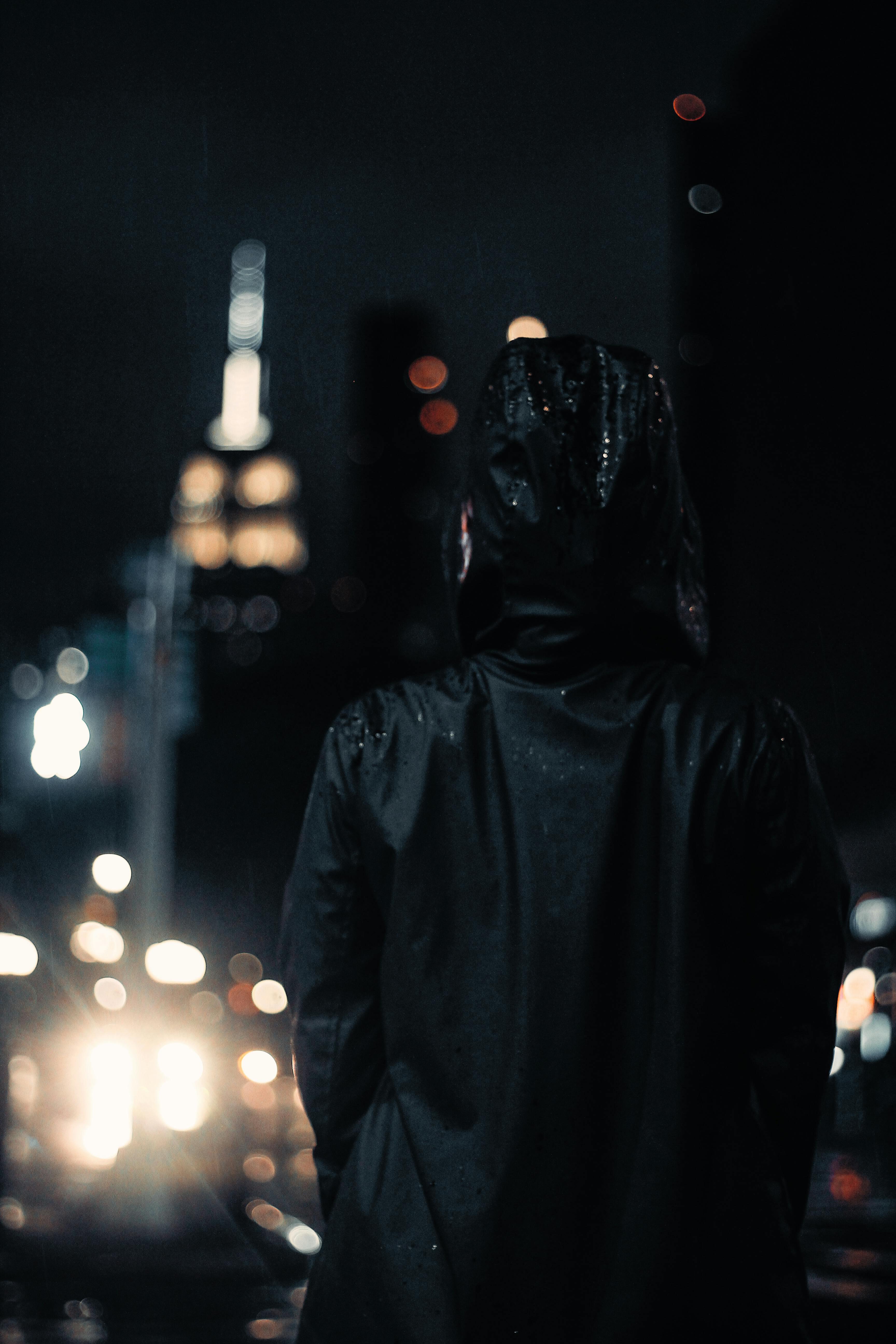 Person in Black Jacket Standing with Arms Raised · Free Stock Photo