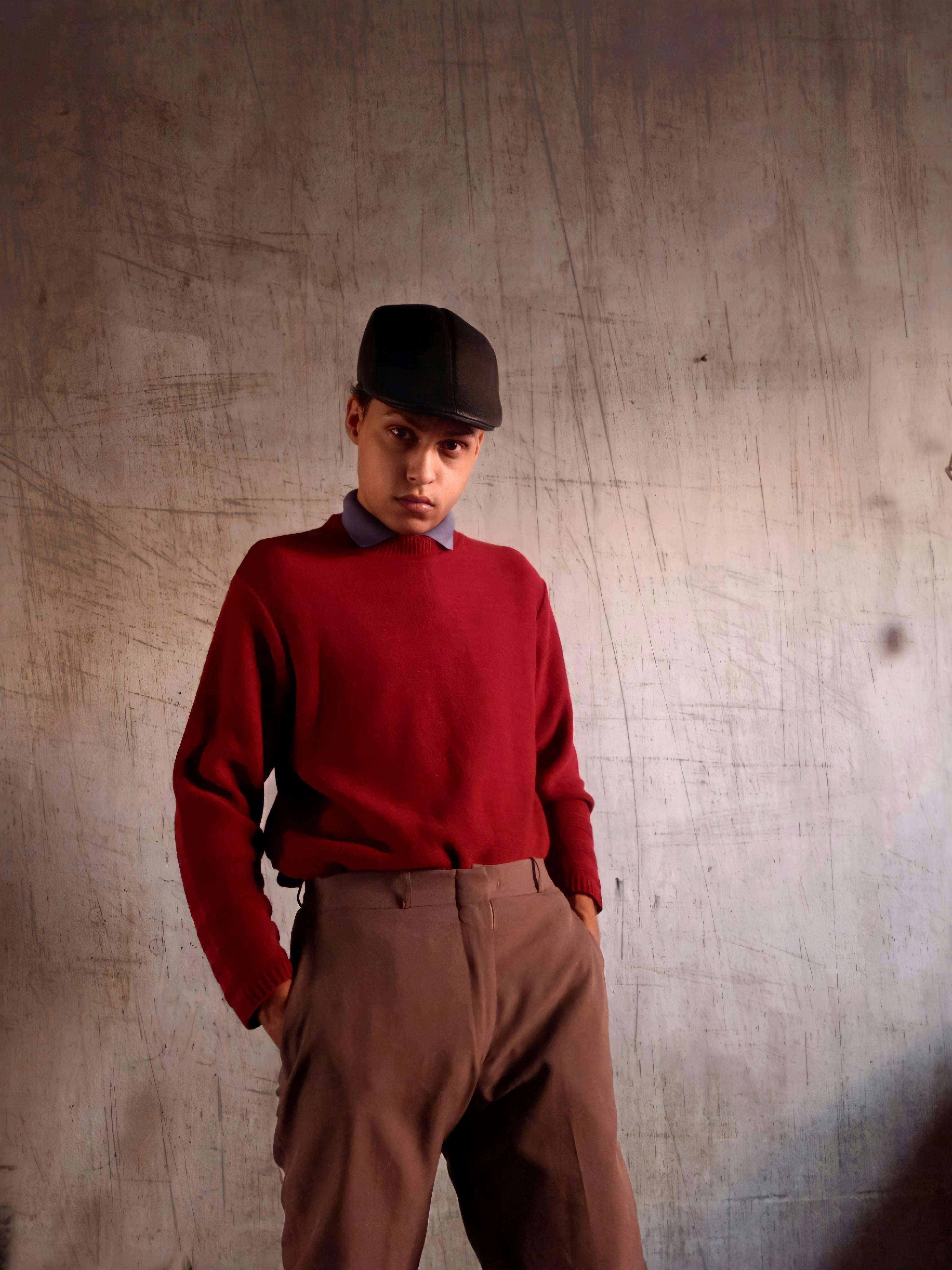 Man in Red Sweater and Black Cap Hands on His Pocket · Free Stock Photo