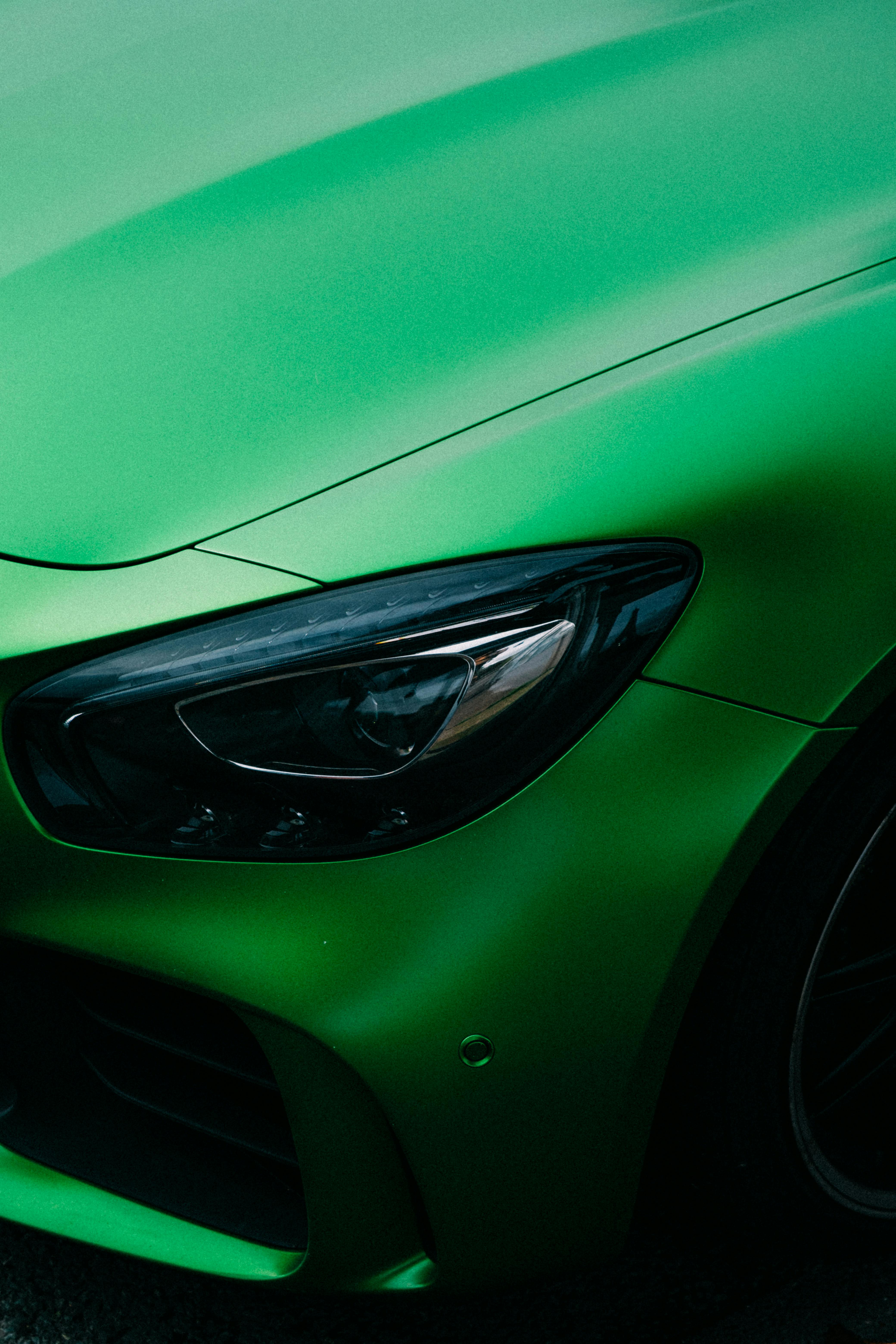 Close-Up Shot of Green Mercedes Benz AMG Headlight · Free Stock Photo