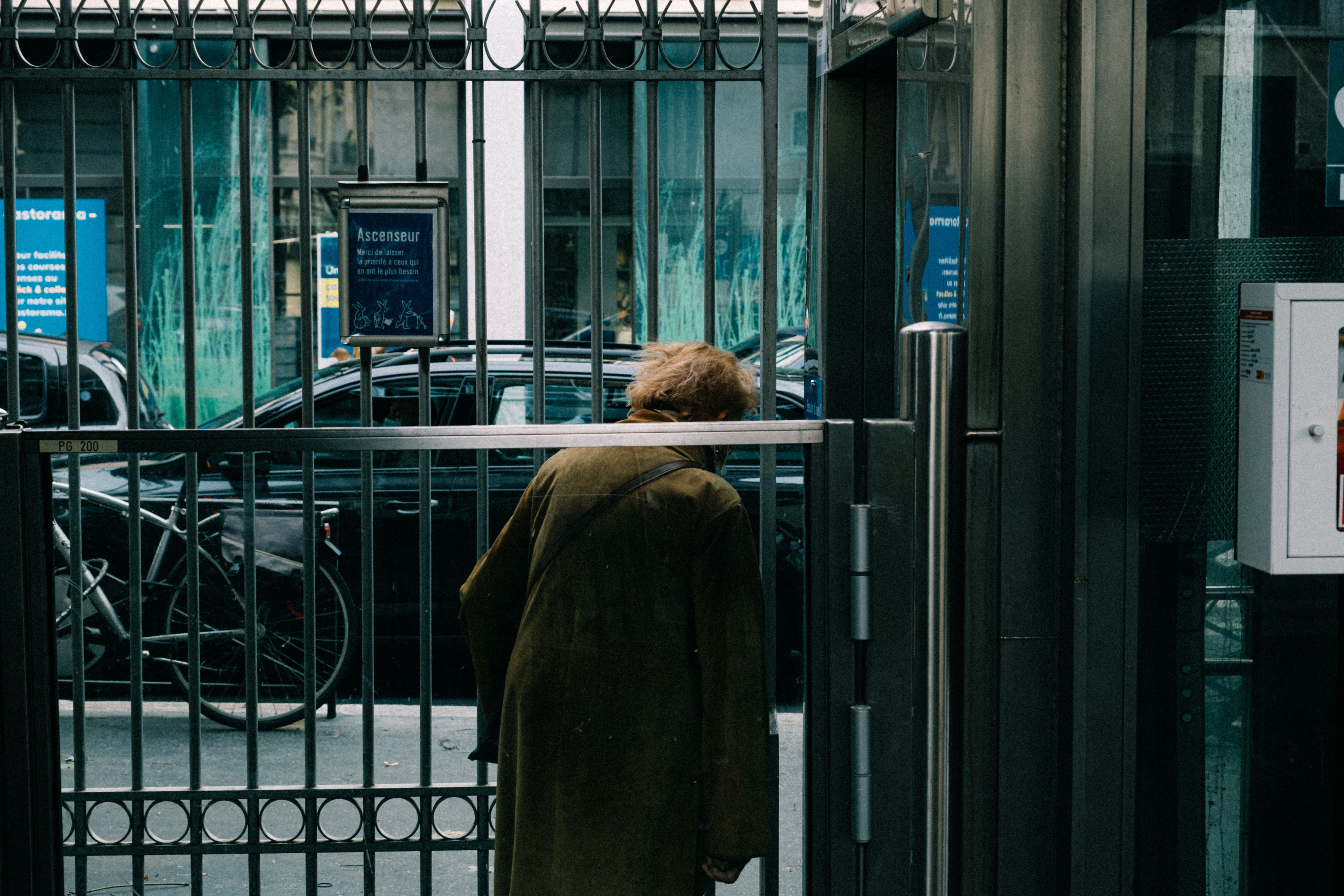 Woman Waiting for a Gate to Open · Free Stock Photo